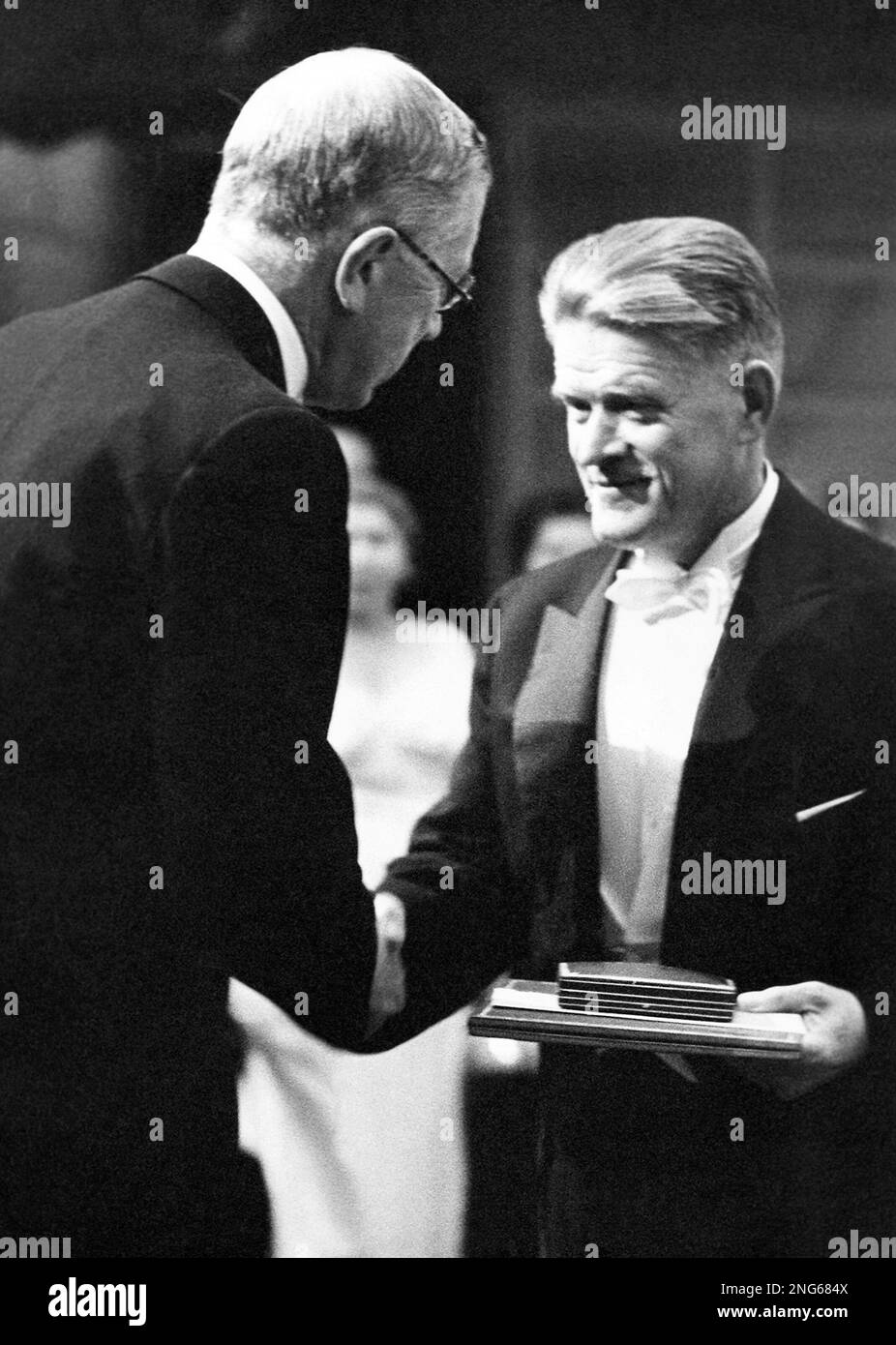 Dr. Pavel Cherenkov of the Soviet Union shakes hands with King Gustaf ...