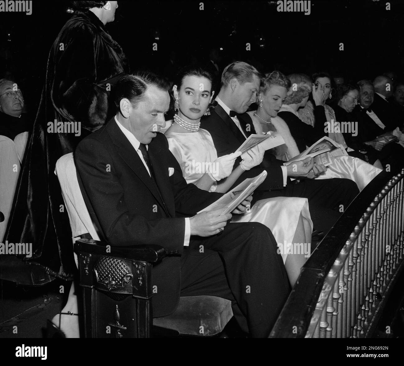 Heiress Gloria Vanderbilt is seated beside singer Frank Sinatra, left ...