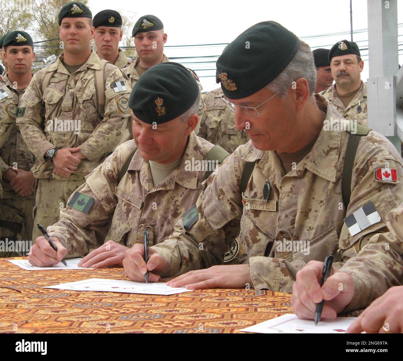 Brig.-Gen Tim Grant (right), signs change of command documents beside ...