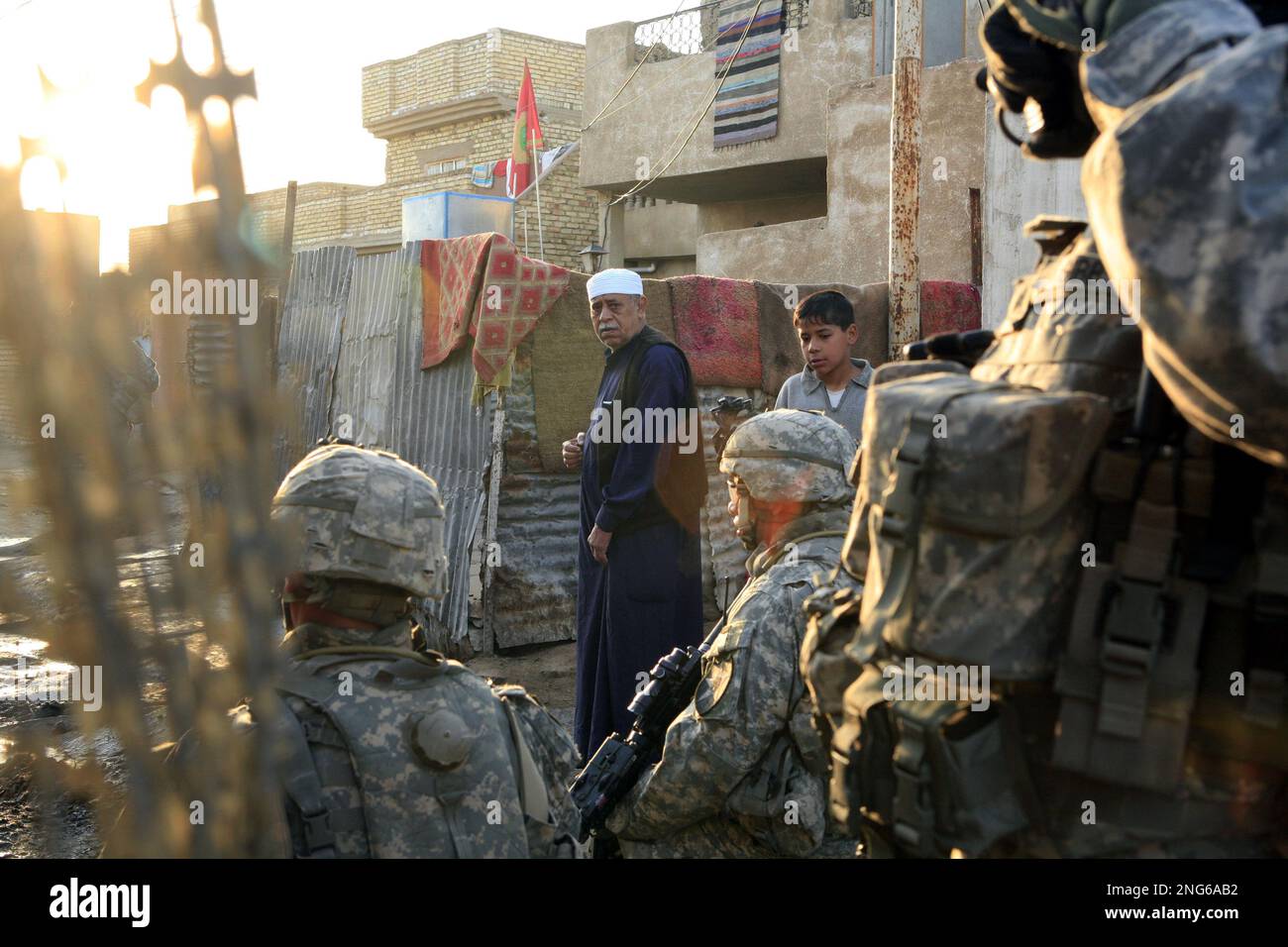 An Iraqi man watches the 5th Battalion, 20th Infantry Regiment of the ...