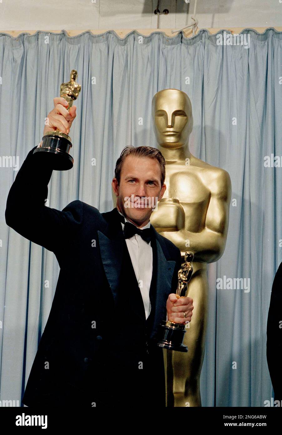 Actor Kevin Costner holds two of the seven Oscars his film "Dances With ...