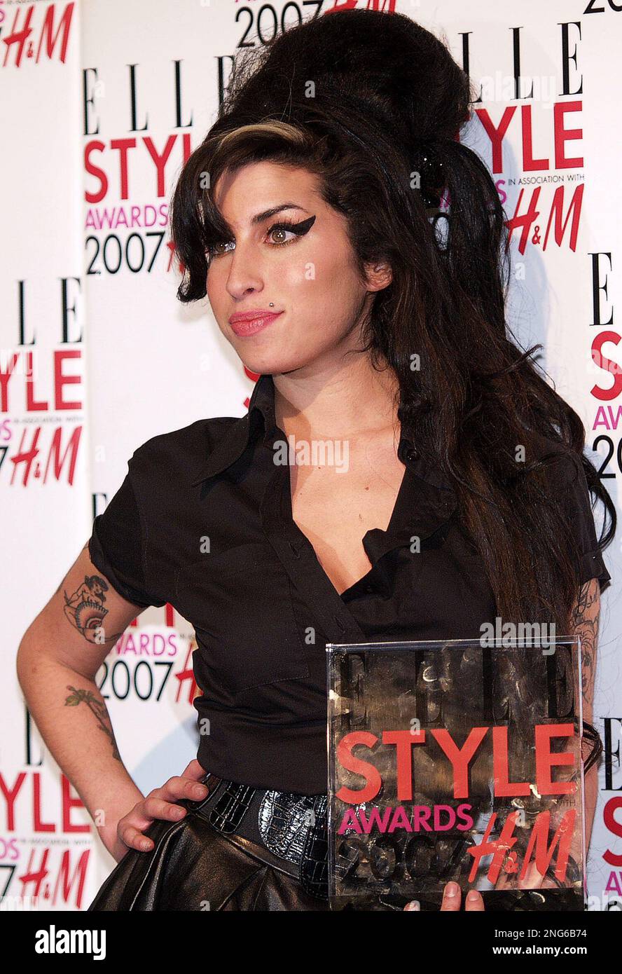 British singer Amy Winehouse holds her Best British Music Act award ...