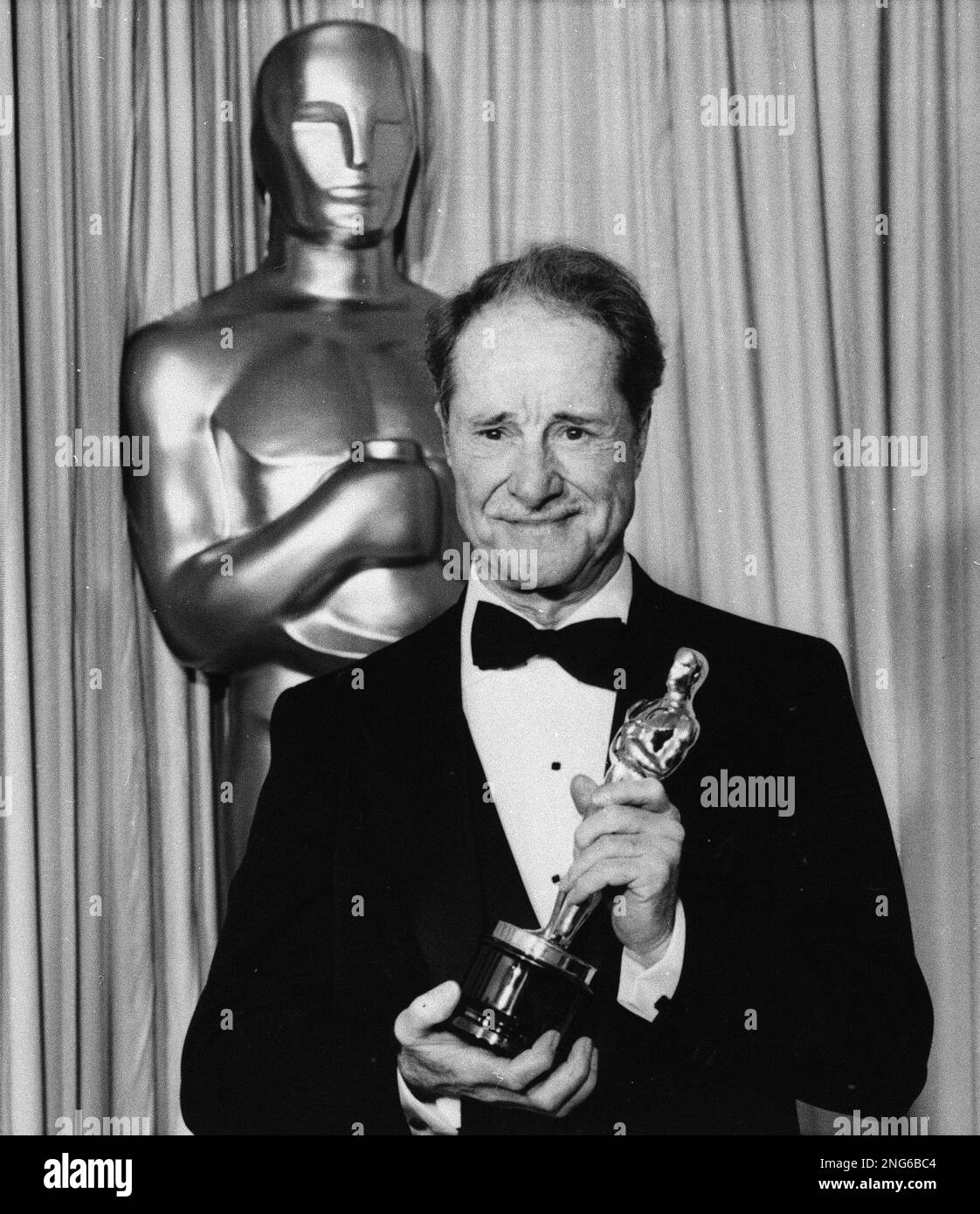 Veteran actor Don Ameche holds Oscar he won for best supporting actor ...