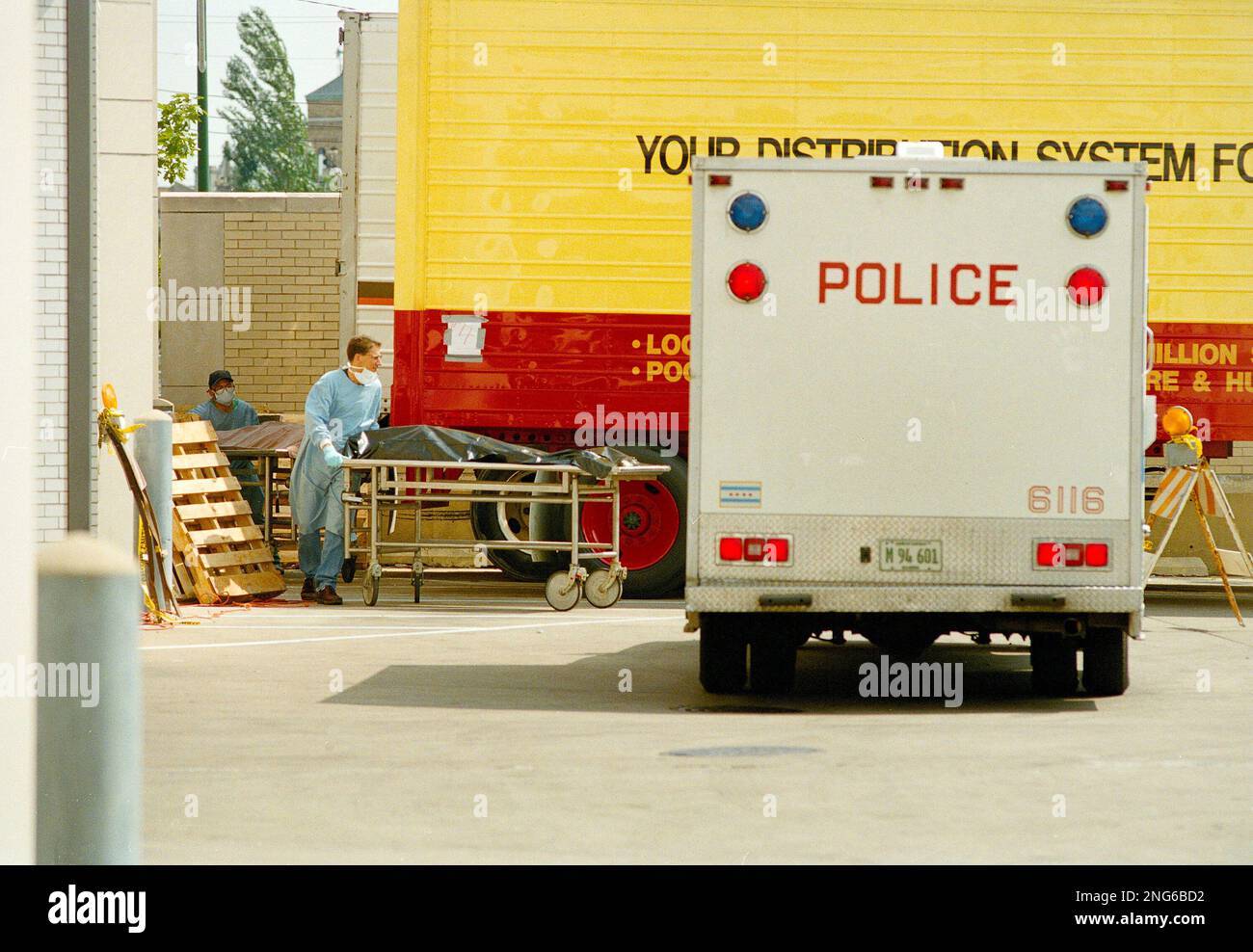 Autopsy technicians move bodies from refrigerated trucks into the Cook ...