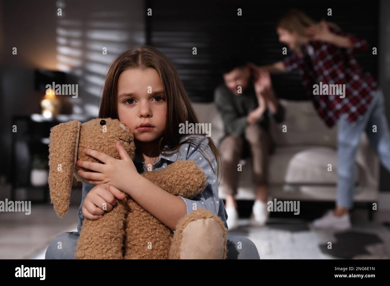 Couple fighting at home, focus on their unhappy little daughter ...