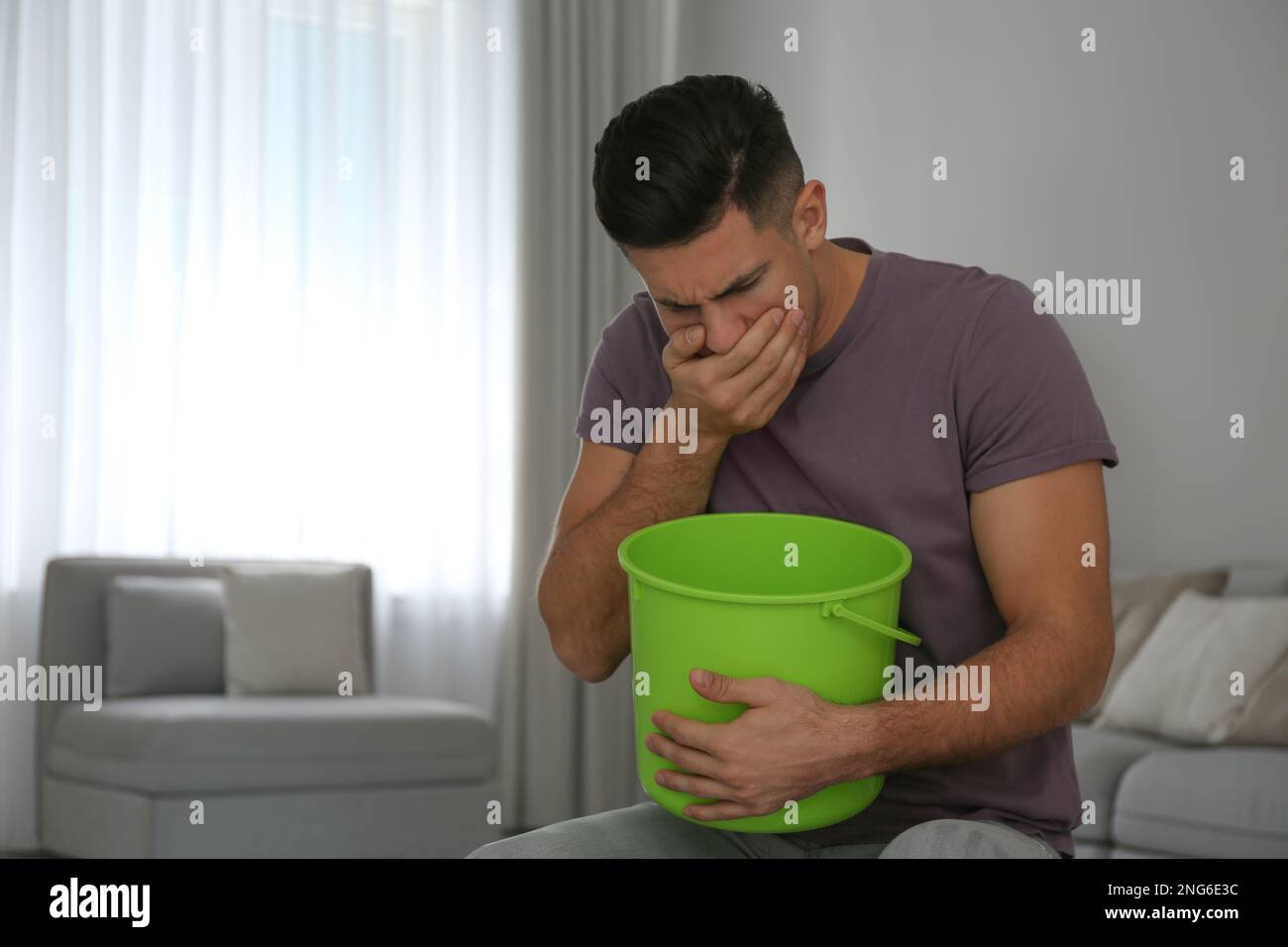 Man vomiting bucket hi-res stock photography and images - Alamy