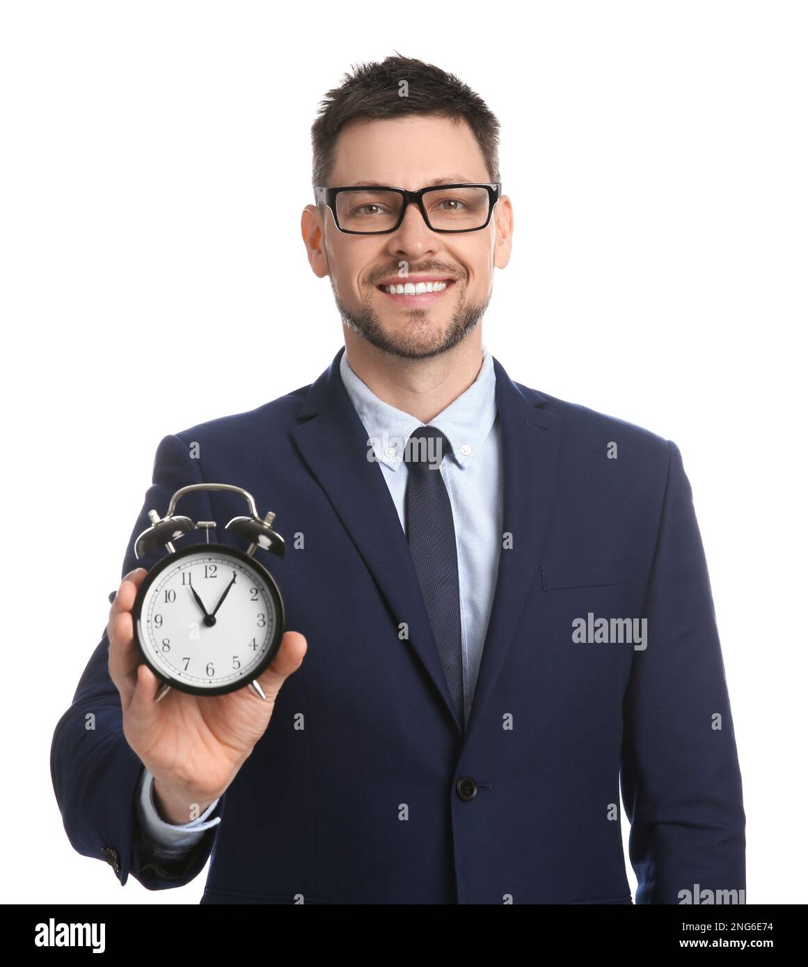 Happy businessman holding alarm clock on white background. Time ...