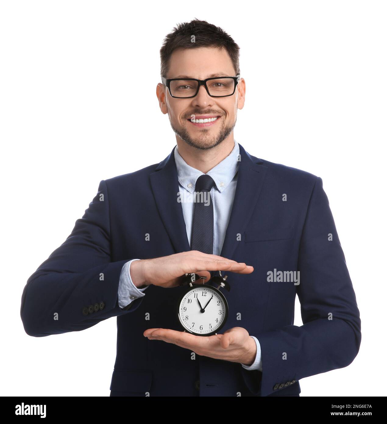 Happy businessman holding alarm clock on white background. Time ...