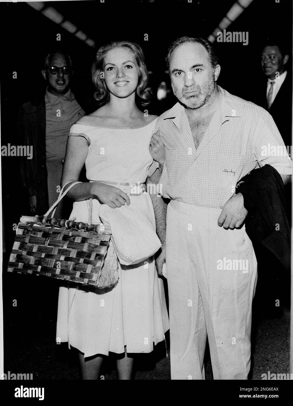 Mickey Cohen, sporting a one inch beard, is greeted by his girl friend ...