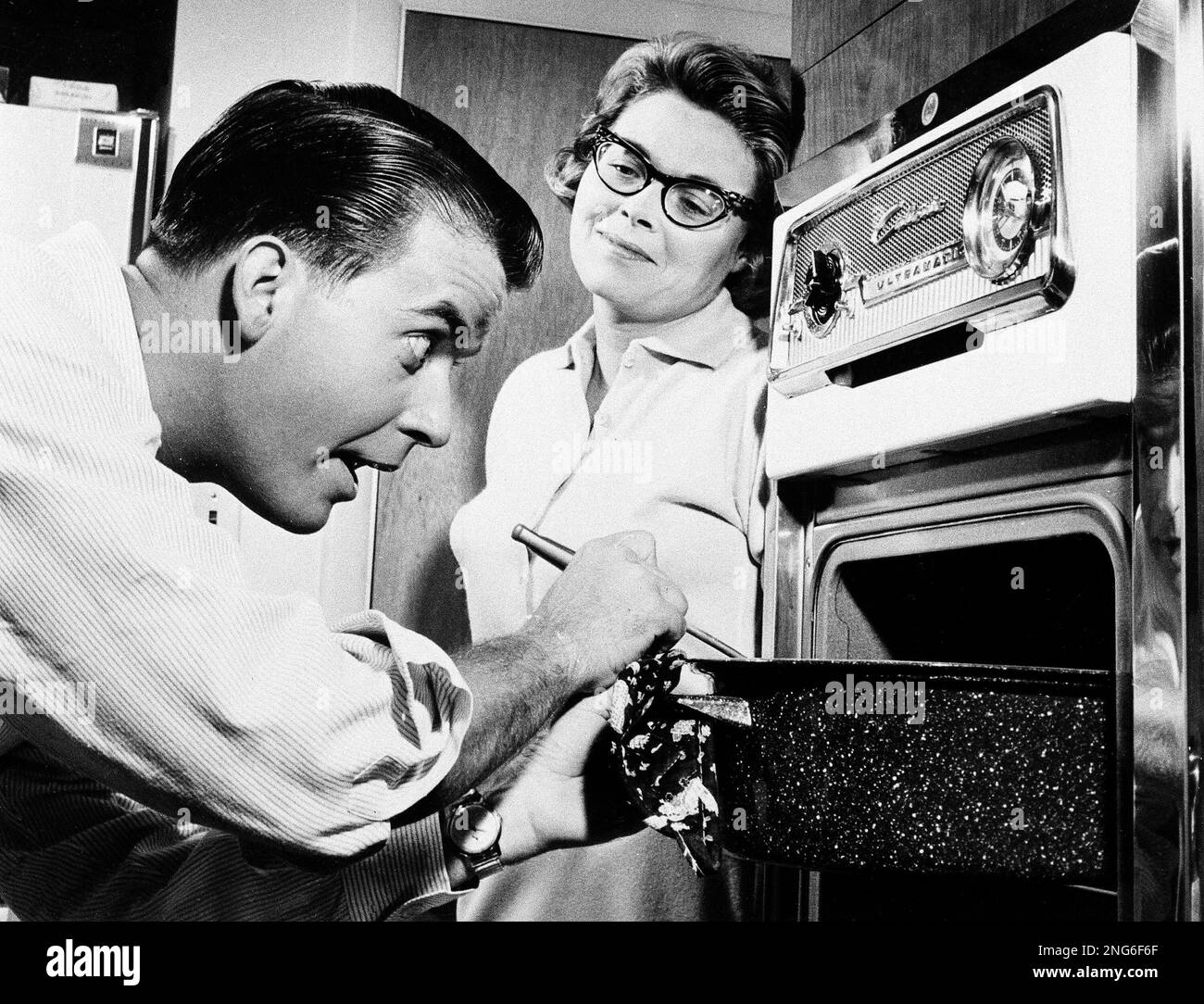 As his wife Barbara Mallery looks on Dick Clark does a bit of kitchen ...