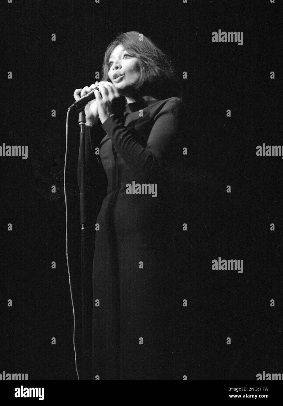 French actress and singer Juliette Greco in her black dress, with hands ...