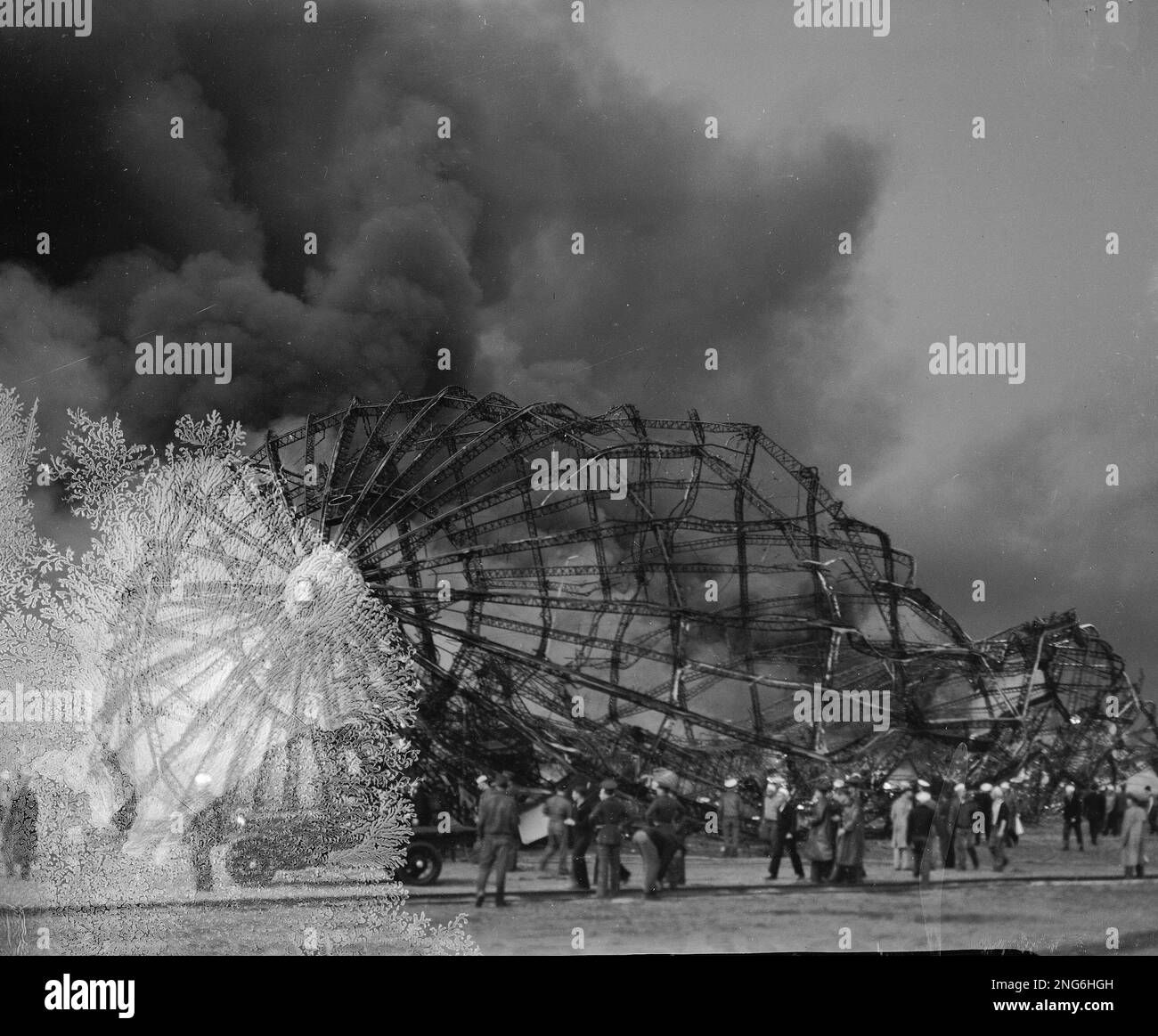 Clouds of smoke rise from the twisted metal frame of the German airship ...