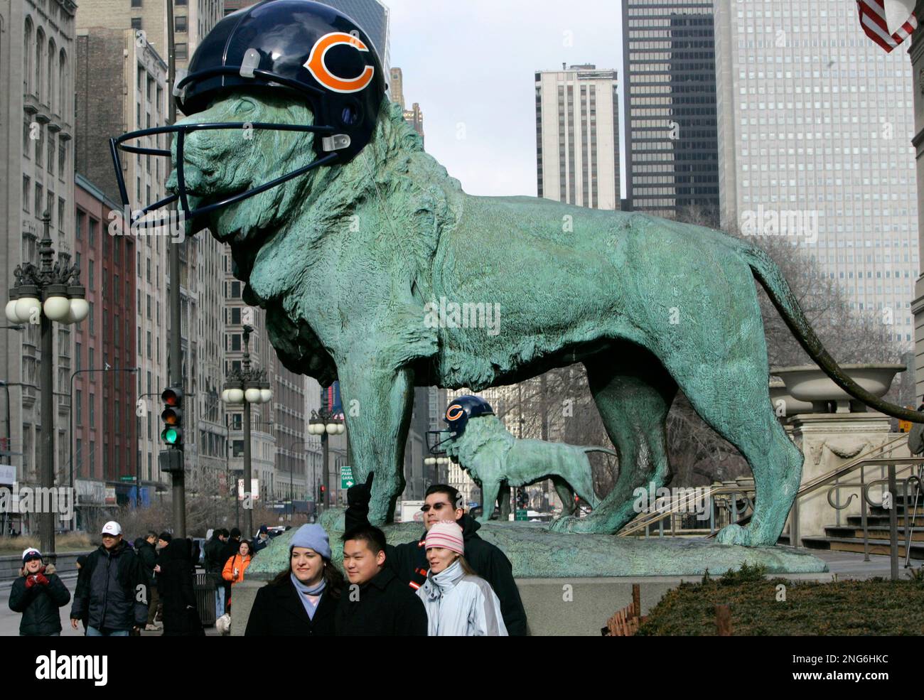 Visitors pose for photos with the bronze lion standing outside the Art ...