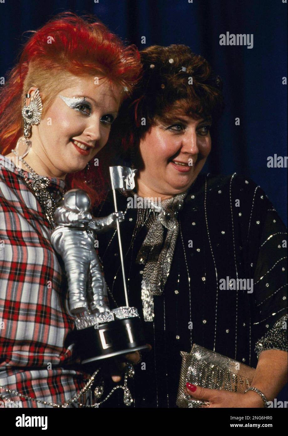 Cindi Lauper, holding the award, posing with her mother at the MTV ...