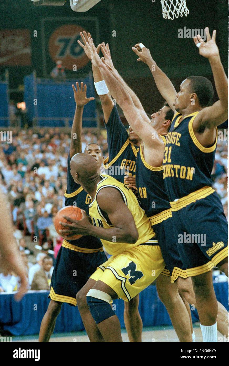 Michigan's Chris Webber is surrounded by four George Washington ...