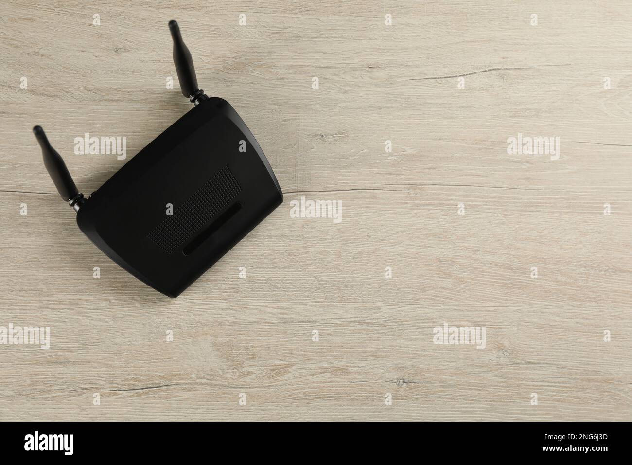 Modern Wi Fi router on wooden background, top view. Space for text ...