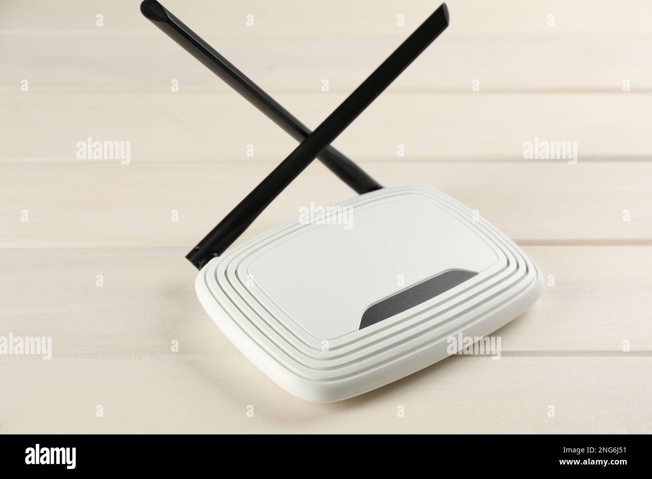 Modern Wi-Fi router on white wooden background Stock Photo - Alamy