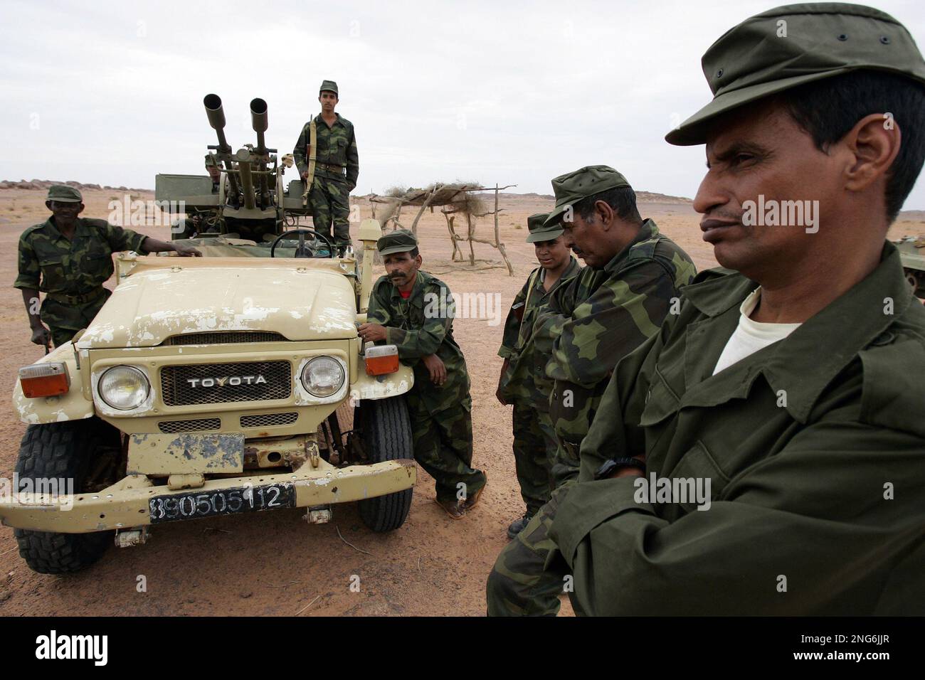 Soldiers from Western Sahara stand by a jeep-mounted anti-aircraft gun ...