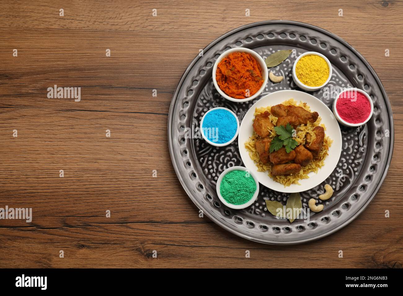 Traditional Indian food and color powders on wooden table, top view ...