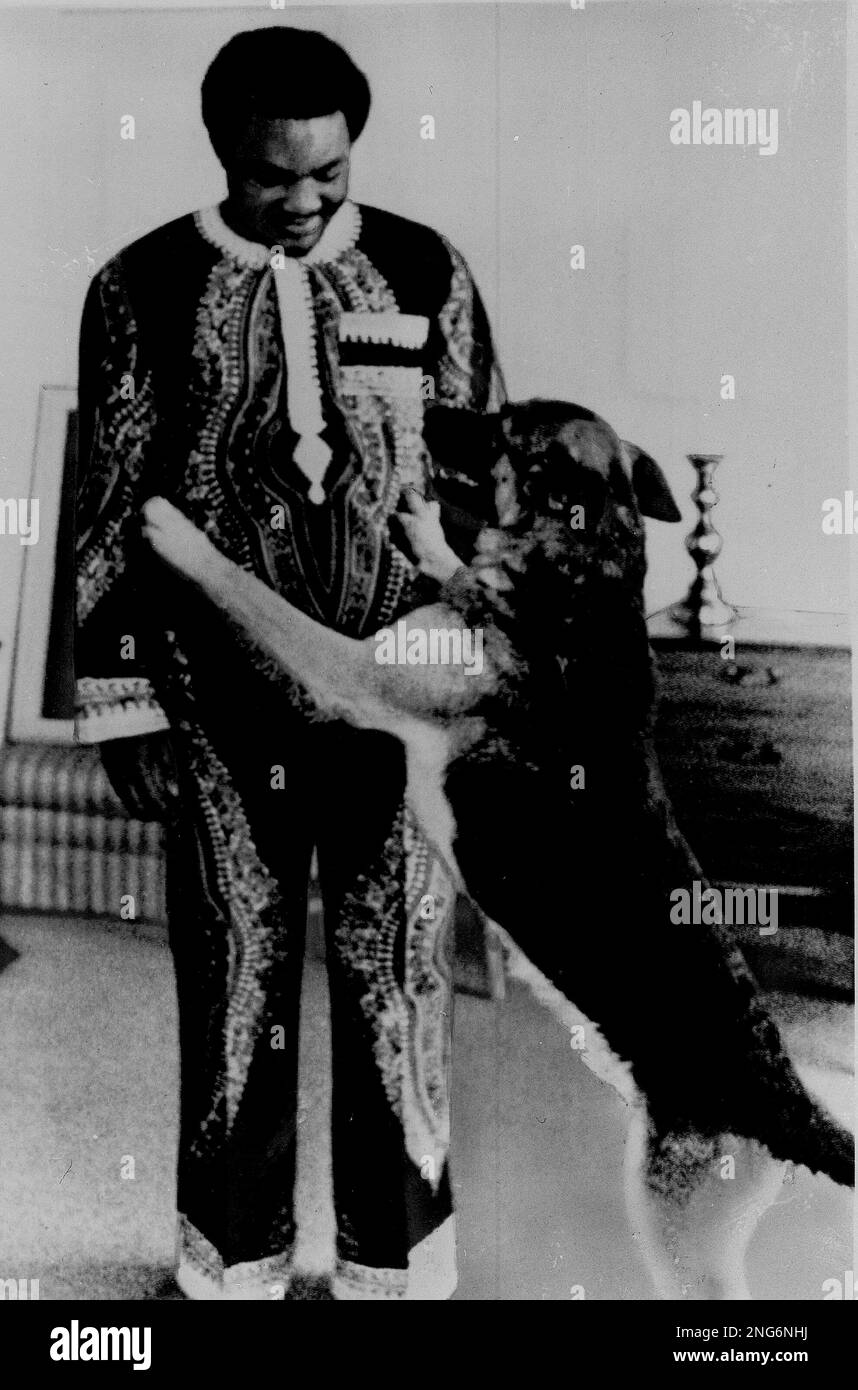 World heavyweight champion George Foreman's dog, Dago, jumps up on him ...