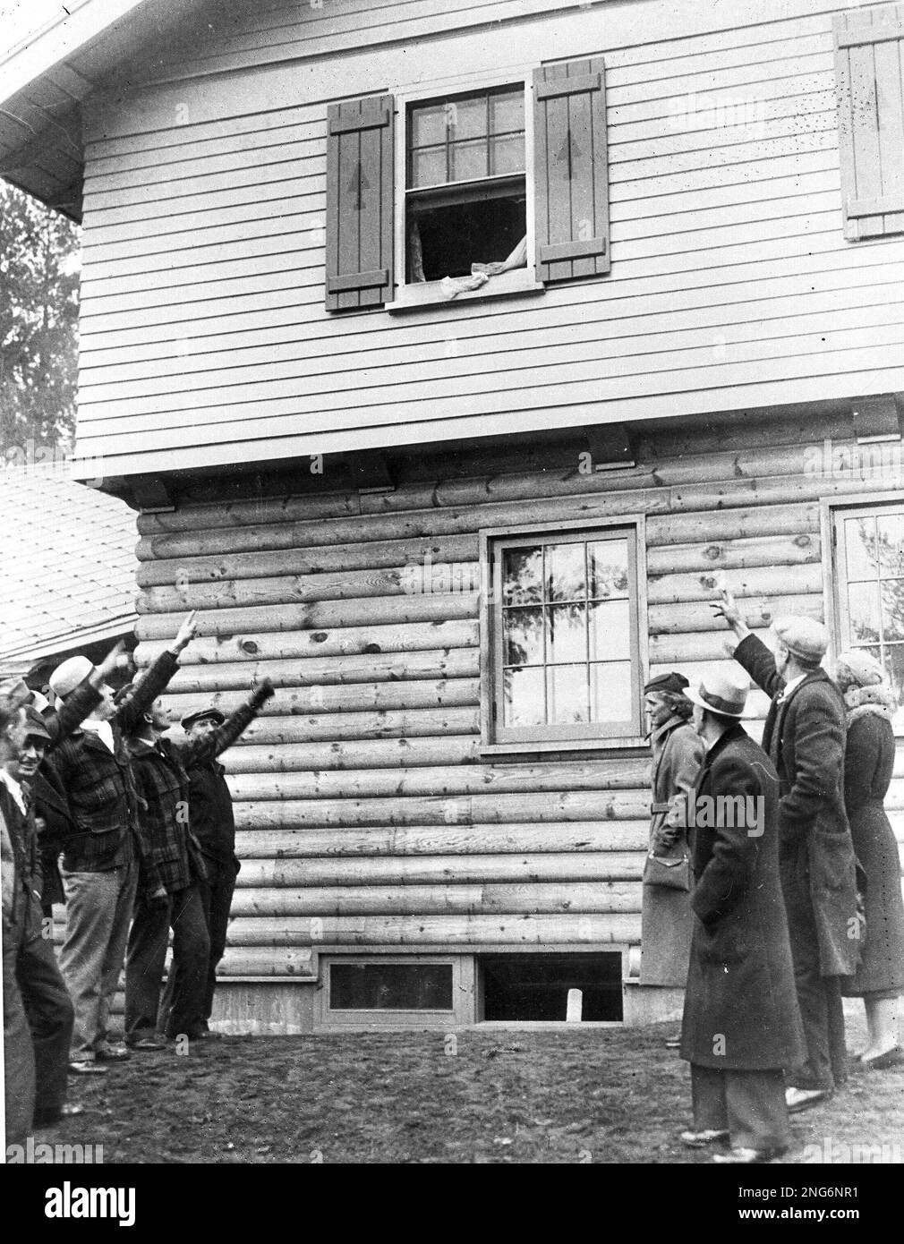 Officers point up at the window in the back of Little Bohemia Roadhouse ...