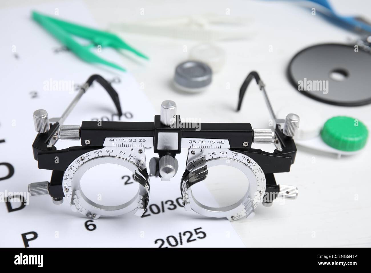 Trial frame with different ophthalmologist tools on white background ...