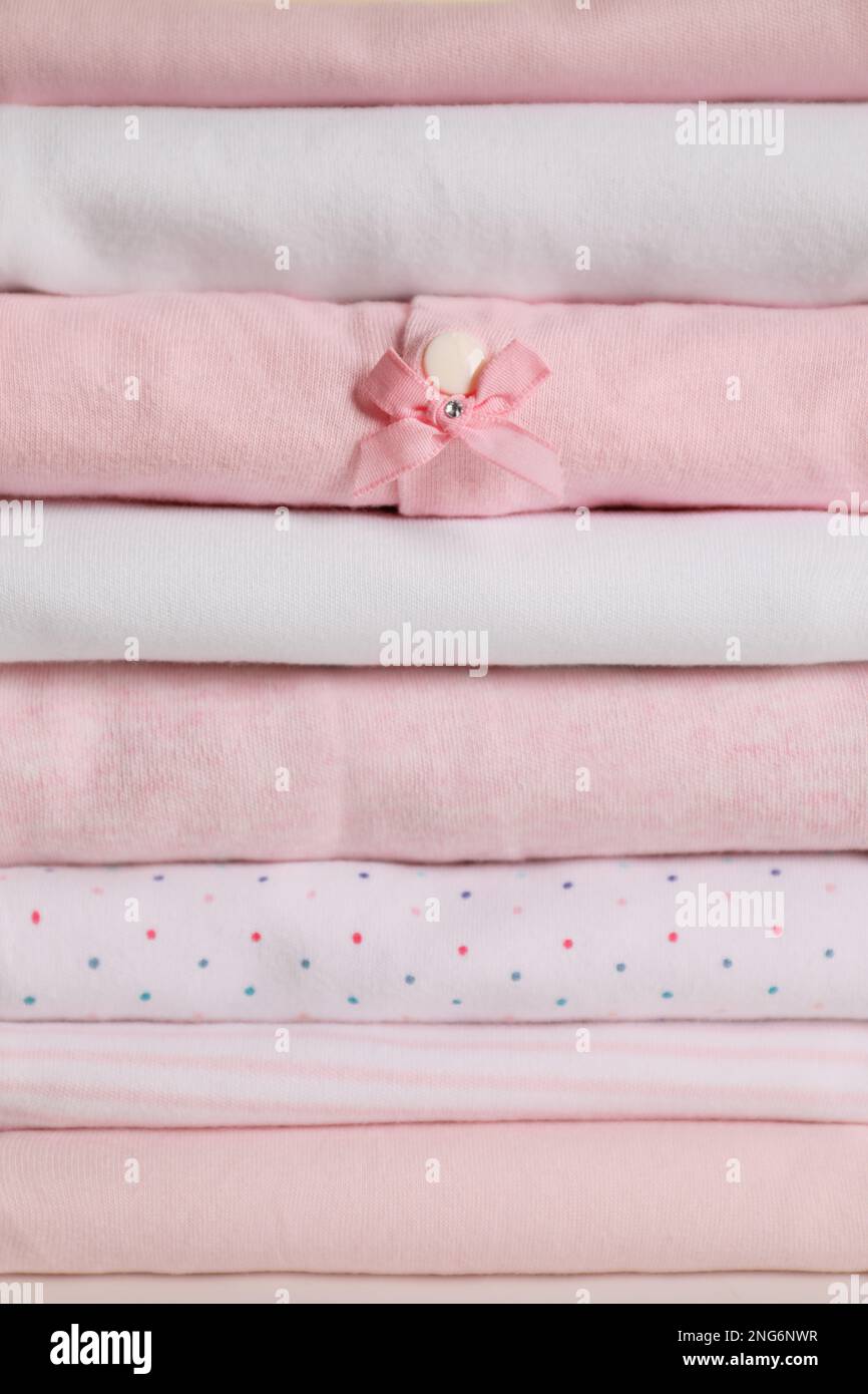 Stack of baby girl's clothes as background, closeup Stock Photo - Alamy