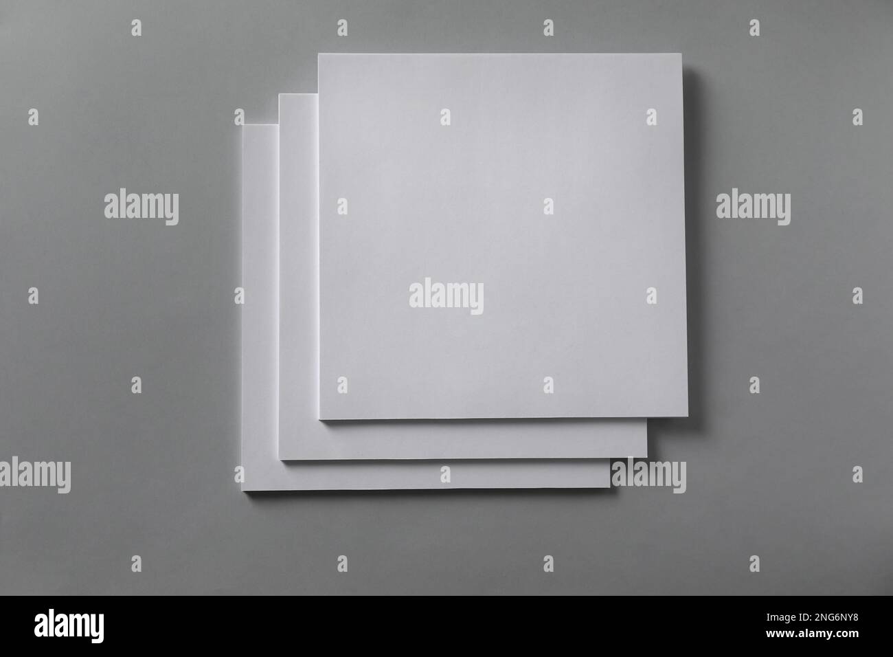 Stack of blank paper sheets for brochure on light grey background, top ...