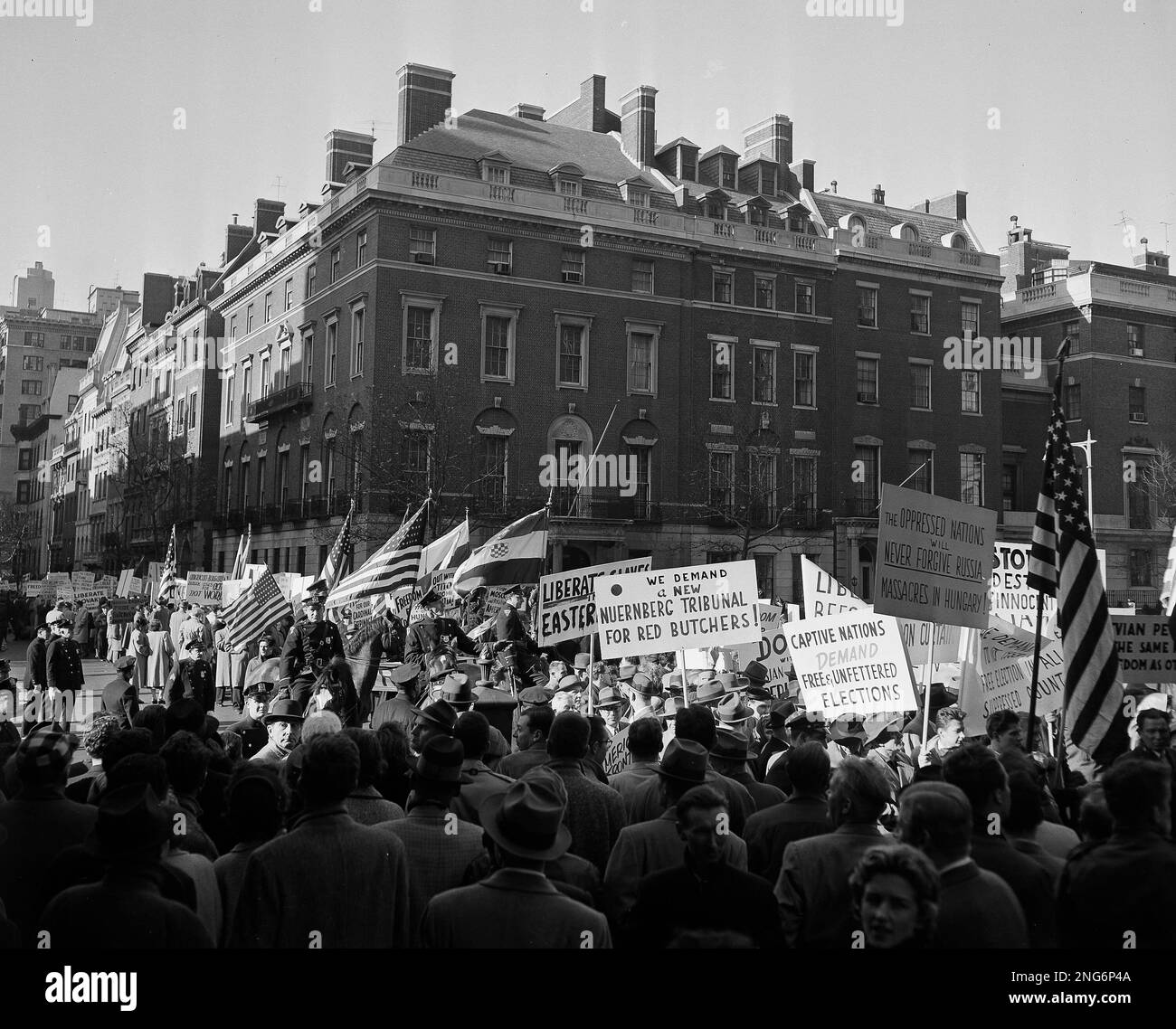 Marchers carrying signs and flags move past the Soviet Union's United ...