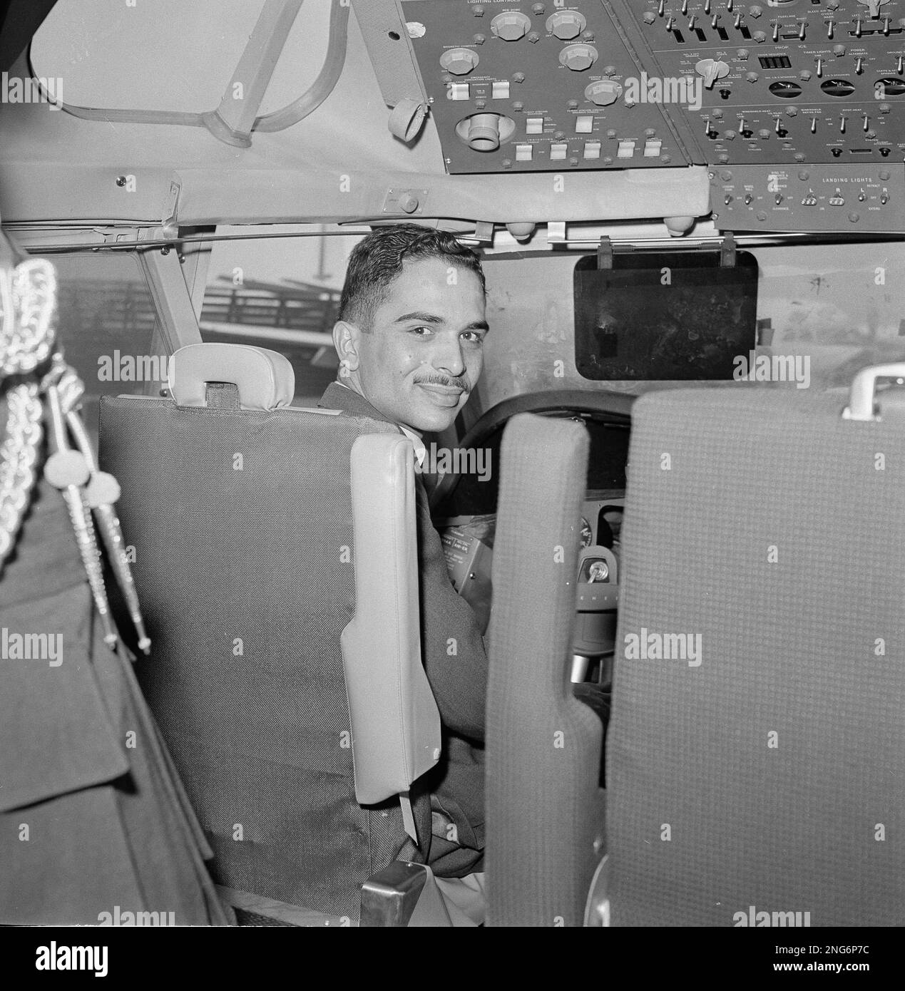 King Hussein II of Jordan sits in the cockpit of a Lockheed Electra ...