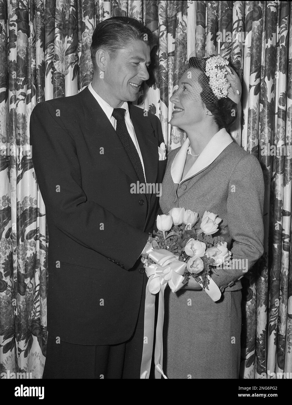 Actor Ronald Reagan and his bride, actress Nancy Davis, smile at each ...