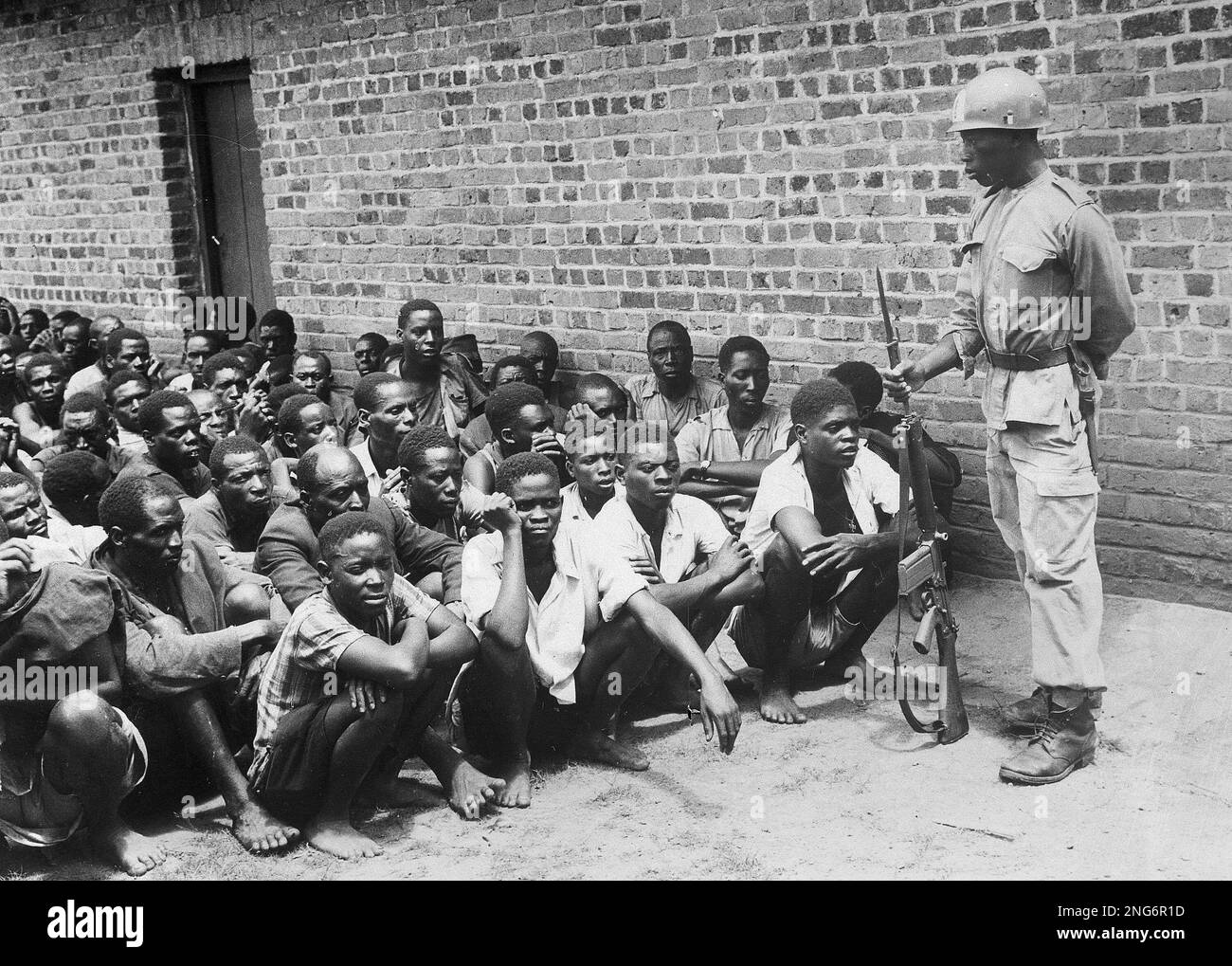 A Belgian Congo soldier stands guard over prisoners captured in the ...