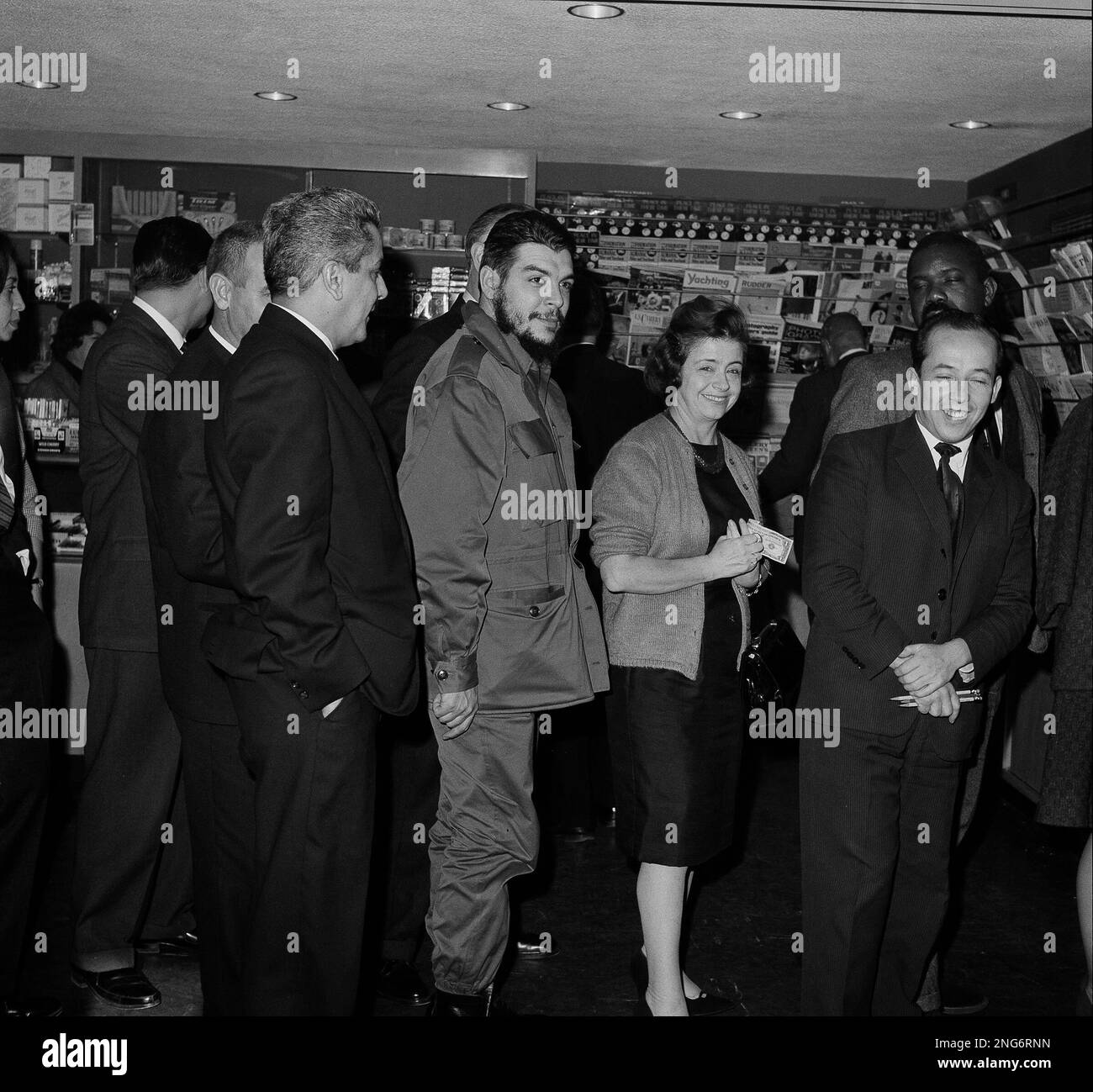Cuba's Minister of Industry, Ernesto "Che" Guevara, waits in line with ...