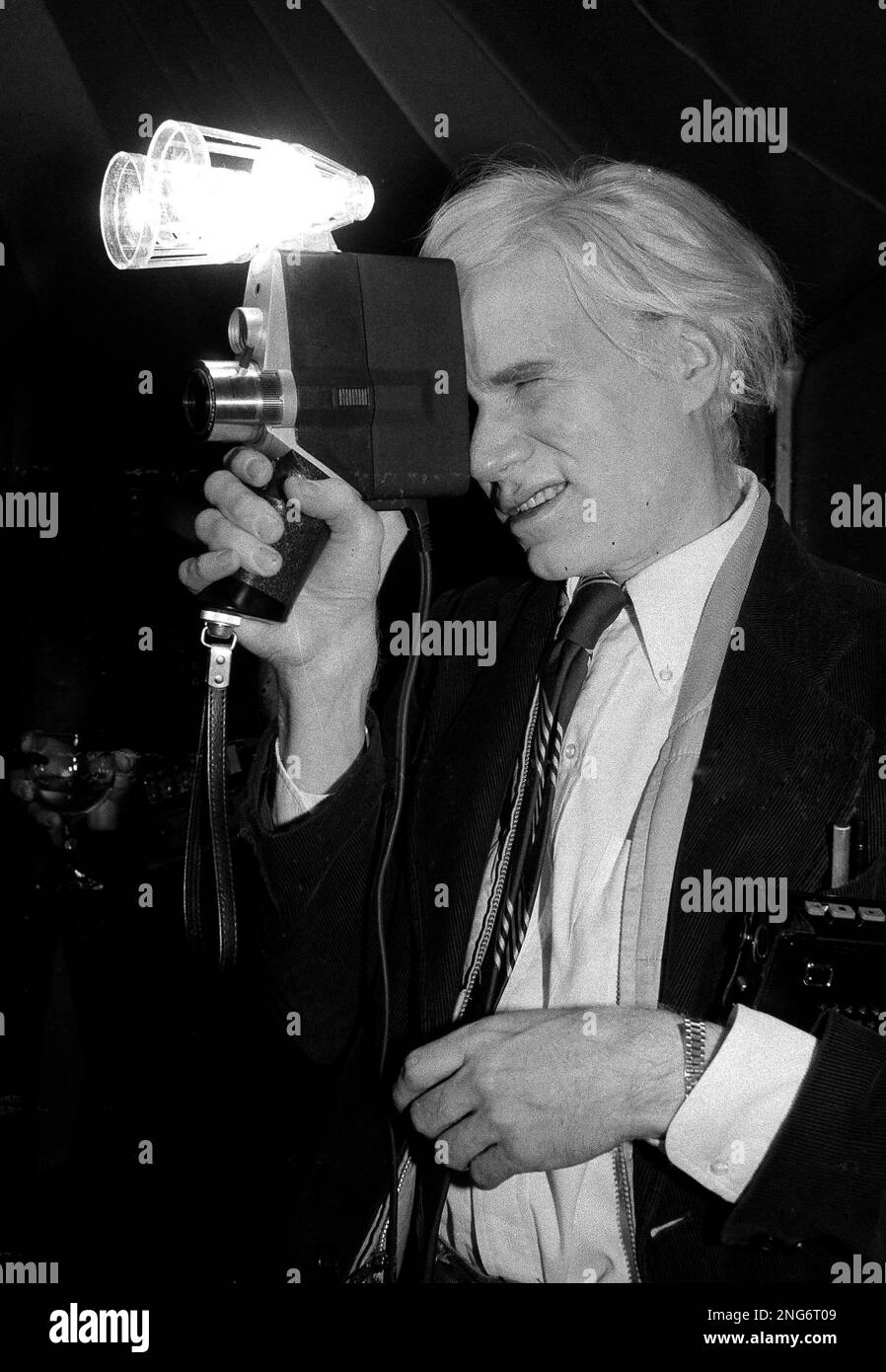 Artist and underground filmmaker Andy Warhol poses with one of Polaroid ...