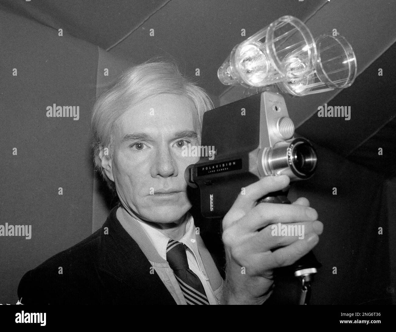 Artist and underground filmmaker Andy Warhol poses with one of Polaroid ...