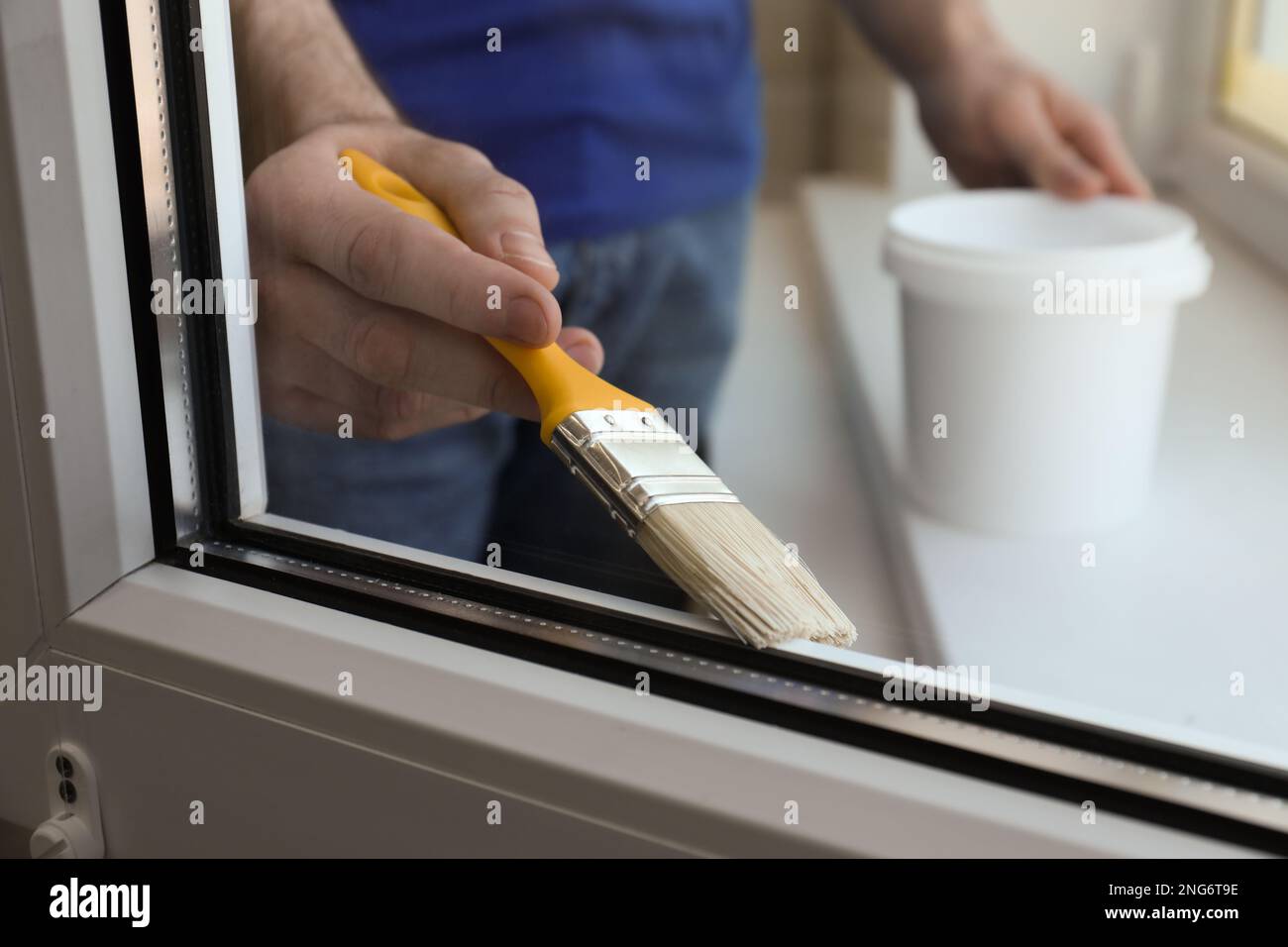 Man painting window frame at home, closeup Stock Photo - Alamy