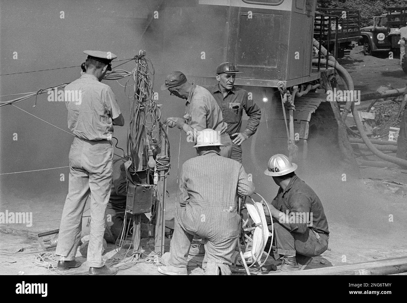 Rescue team members lower food packages to coal miners trapped ...