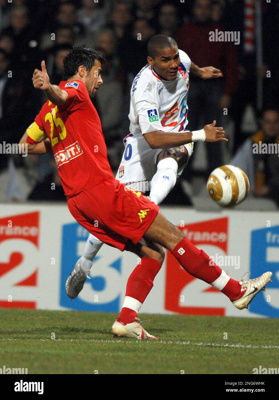 Lyon's forward Florent Malouda, right, and Le Mans's Marko Basa ...