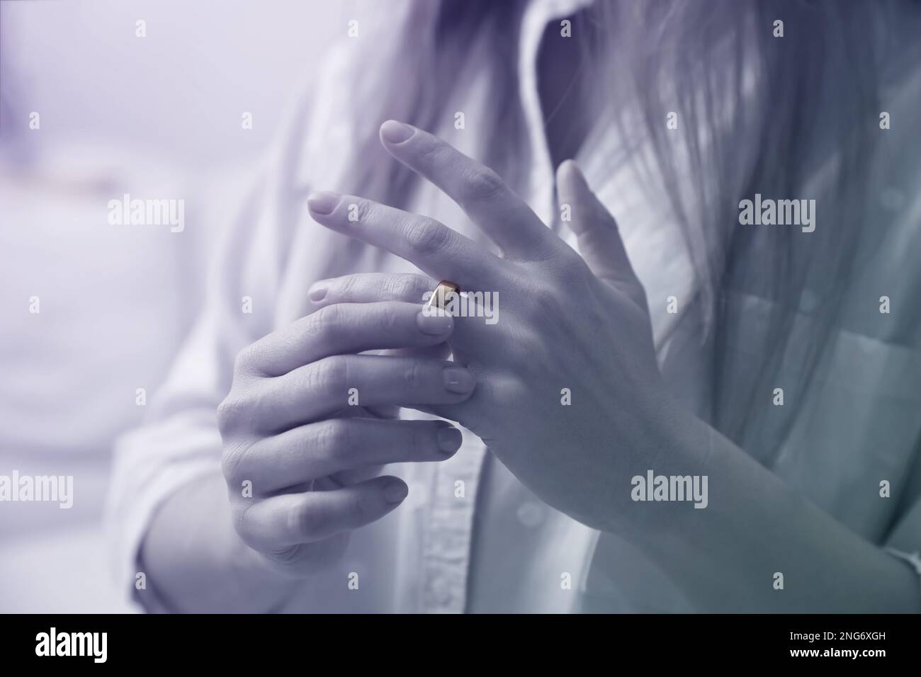 Woman taking off wedding ring indoors, closeup. Cheating and breakup ...