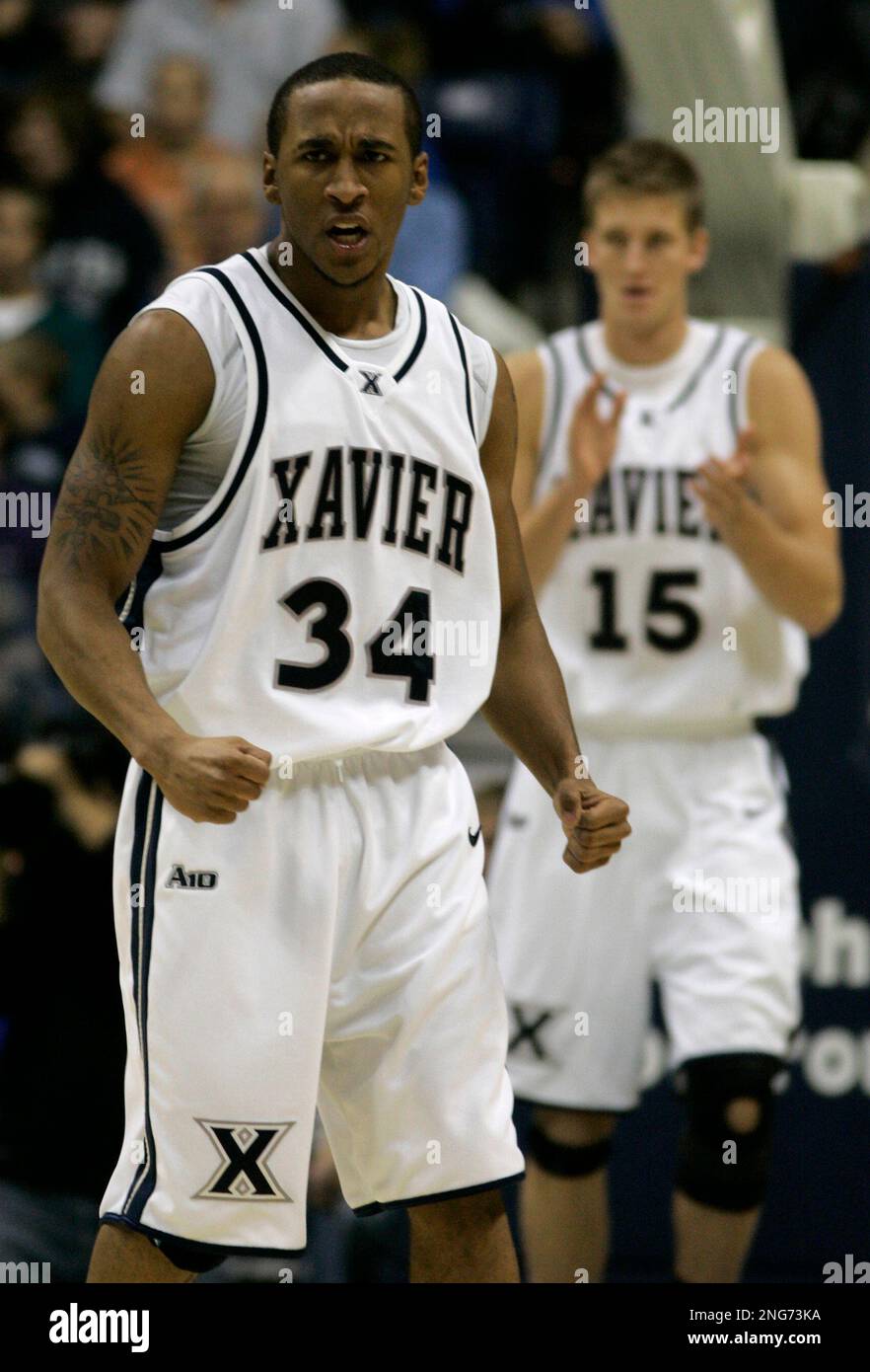 Xavier guard Stanley Burrell (34) and Justin Doellman (15) are shown ...