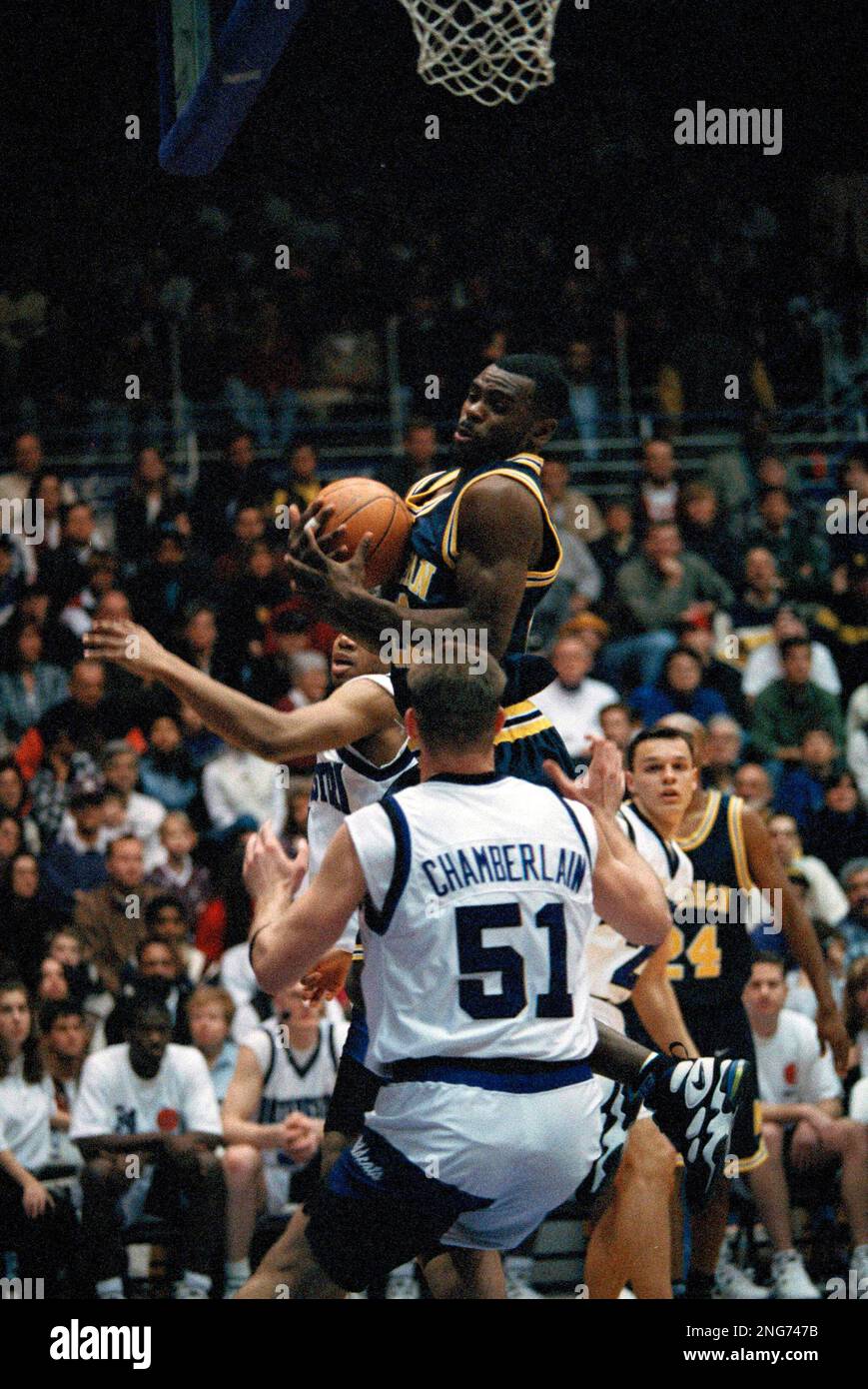 Michigan's Ray Jackson pulls down the rebound ahead of Northwestern's ...