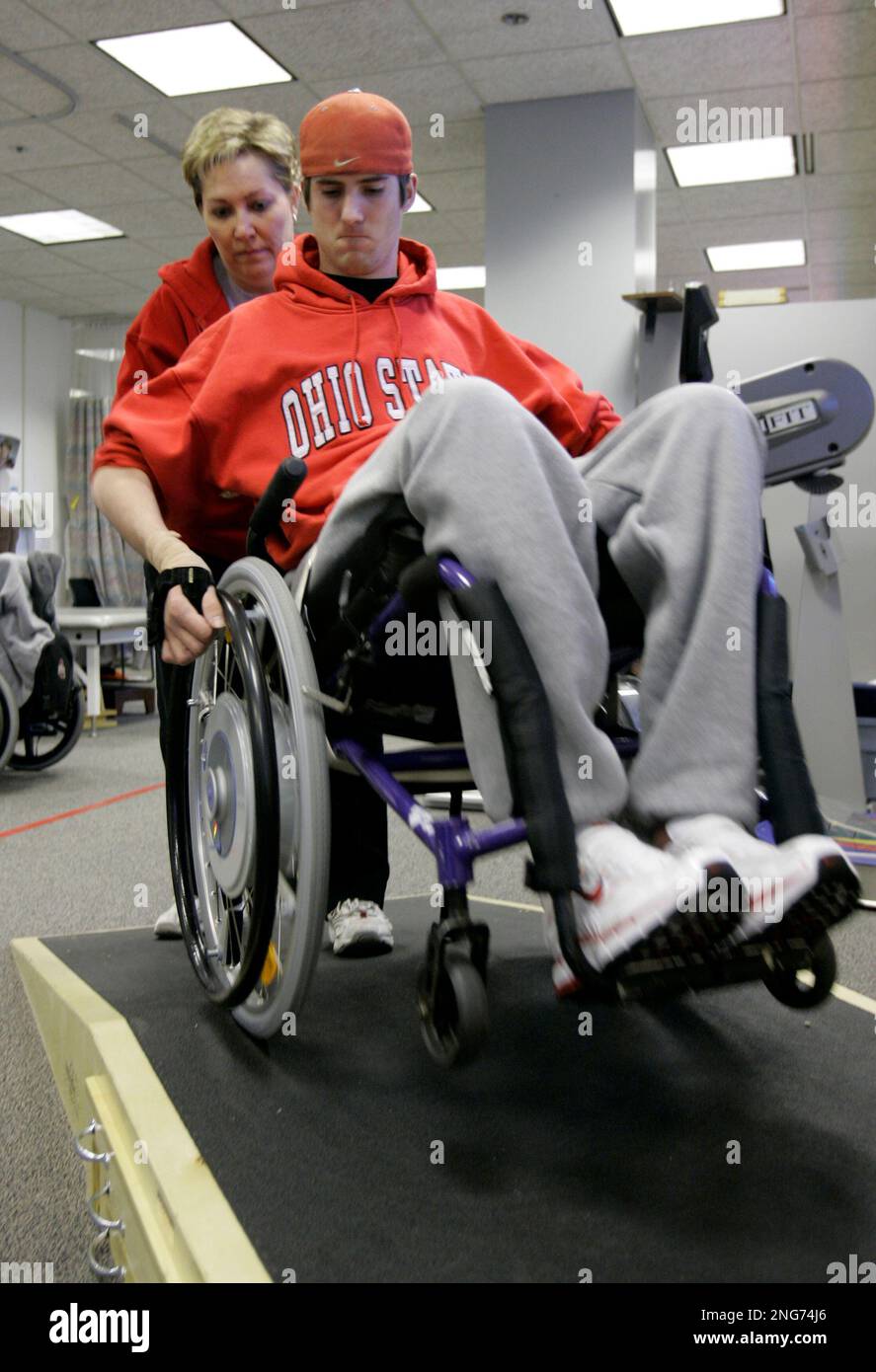 Tyson Gentry uses his arm to pull up on a ramp as he operates a manual ...