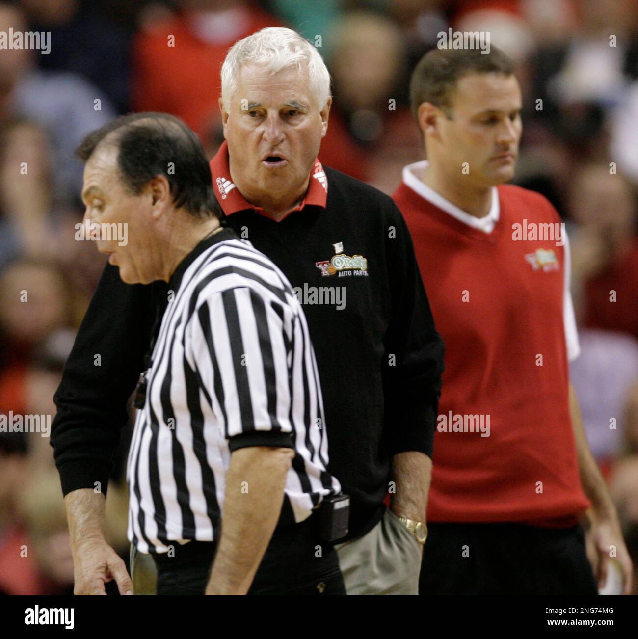 Texas Tech basketball coach Bob Knight, center, argues with a referee ...