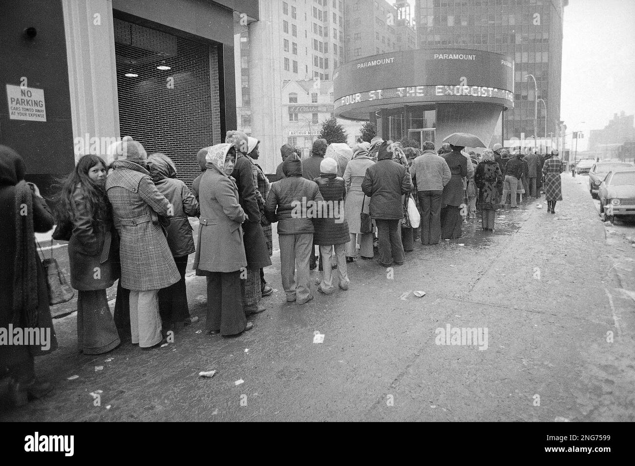 Despite sub-freezing temperatures and rain, a crowd waits in line ...