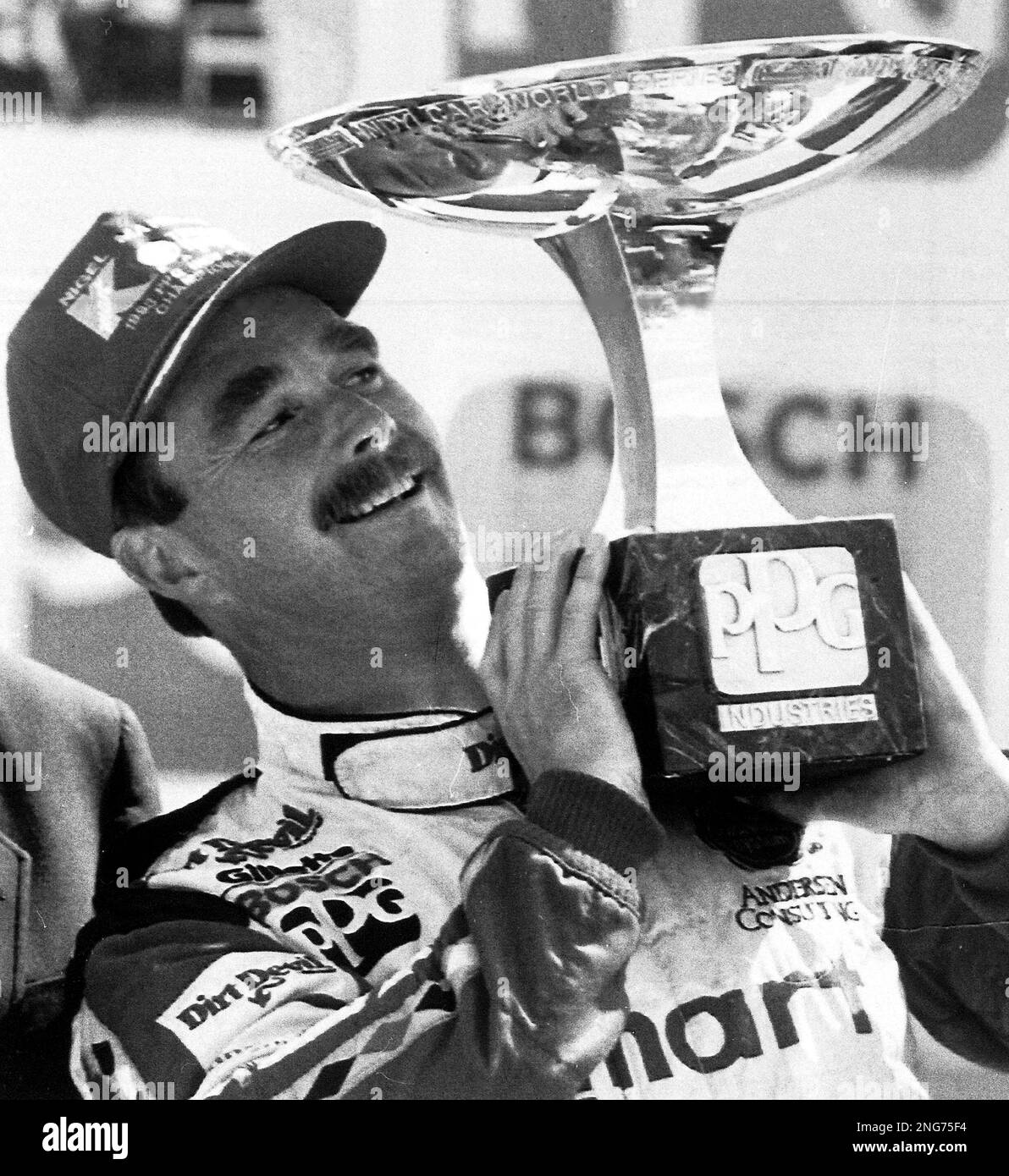 Britain's Nigel Mansell holds the trophy for winning the Indy Car World ...