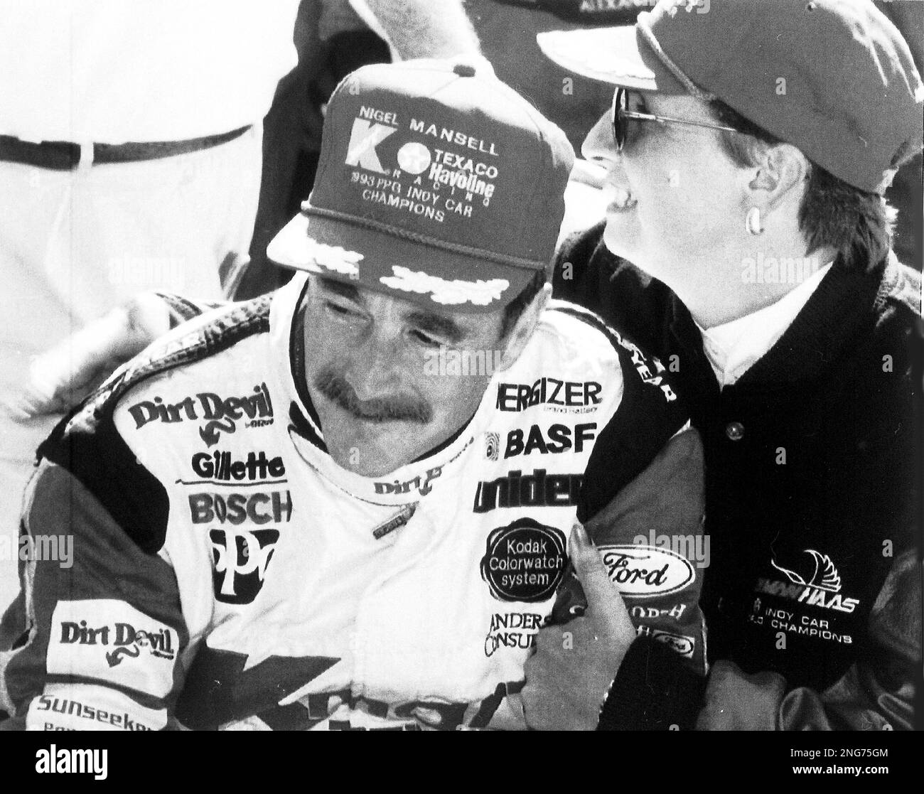 Britain's Nigel Mansell is hugged by his wife, Rosanne, after winning ...