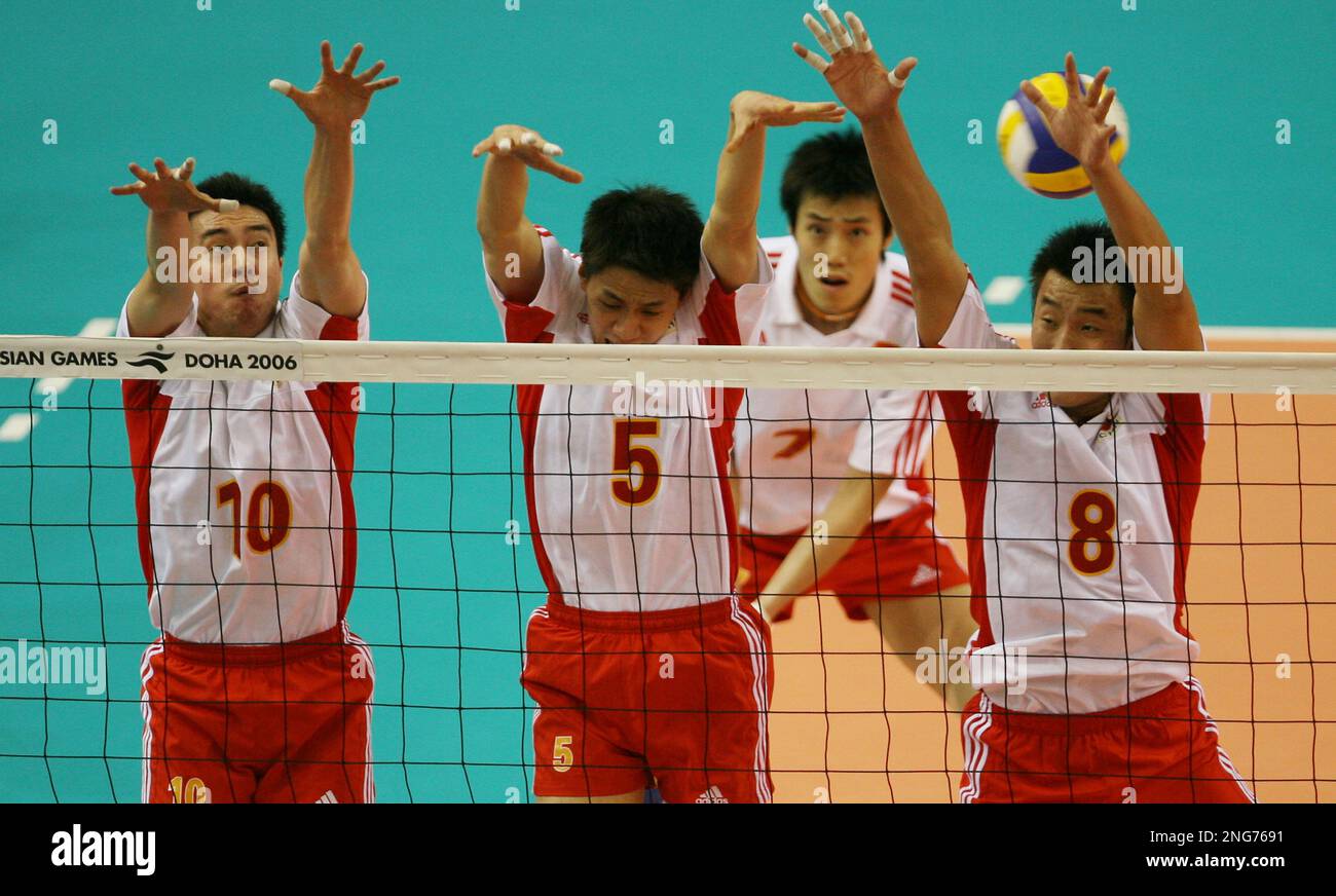 Li Chun, Guo Peng and Cui Jianjun, from left front, try to block a smash as Tang Miao looks on ...
