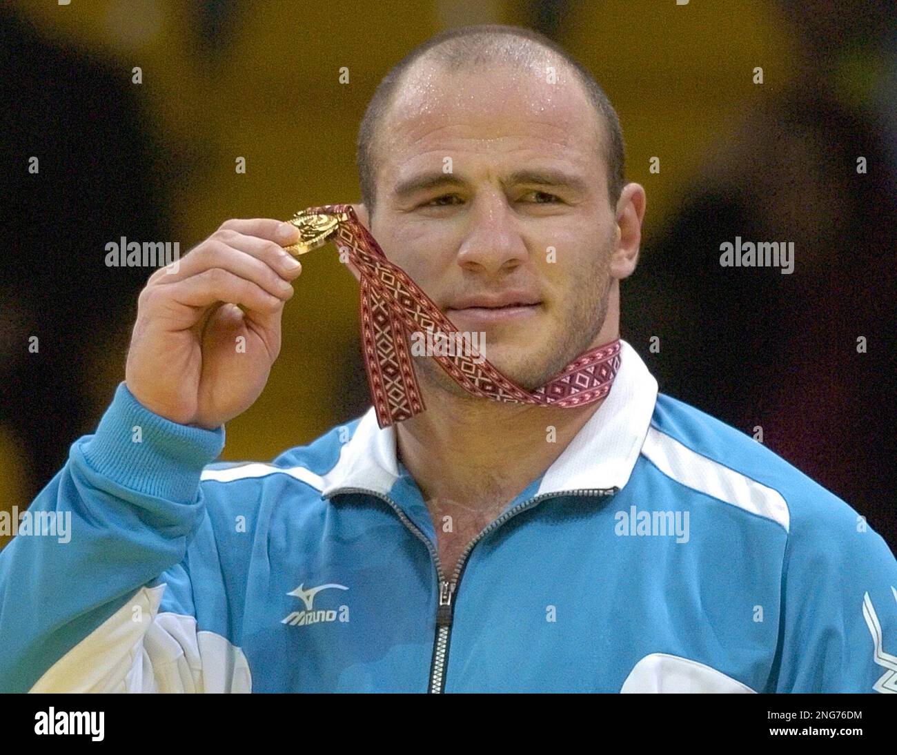 Uzbekistan's Artur Taymazov holds up his gold medal after beating Iran ...