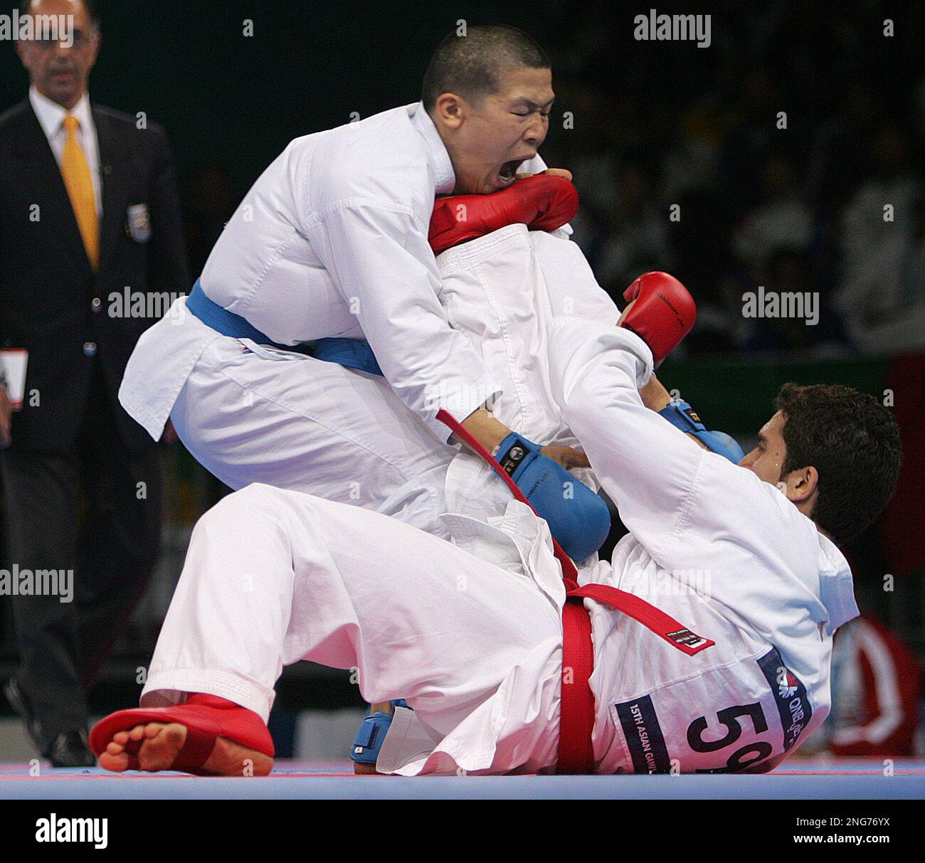 Japan's Takuro Nihei, top, and Lebanon's Ali Younes clash in their Men ...