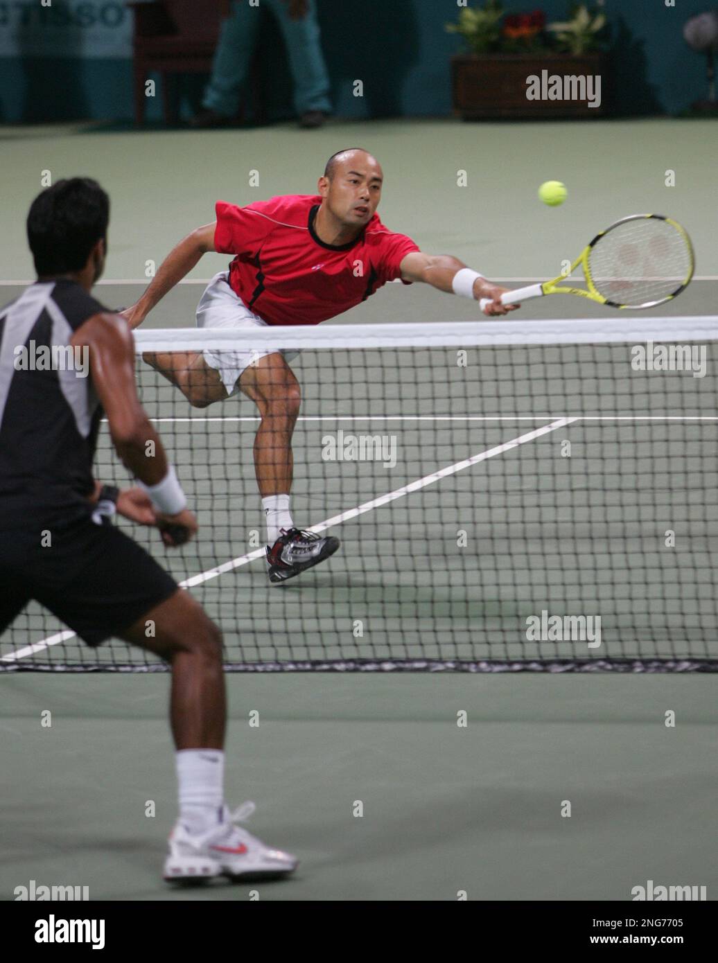 Japan's Satoshi Iwabuchi reaches for the ball as India's Leander Paes ...